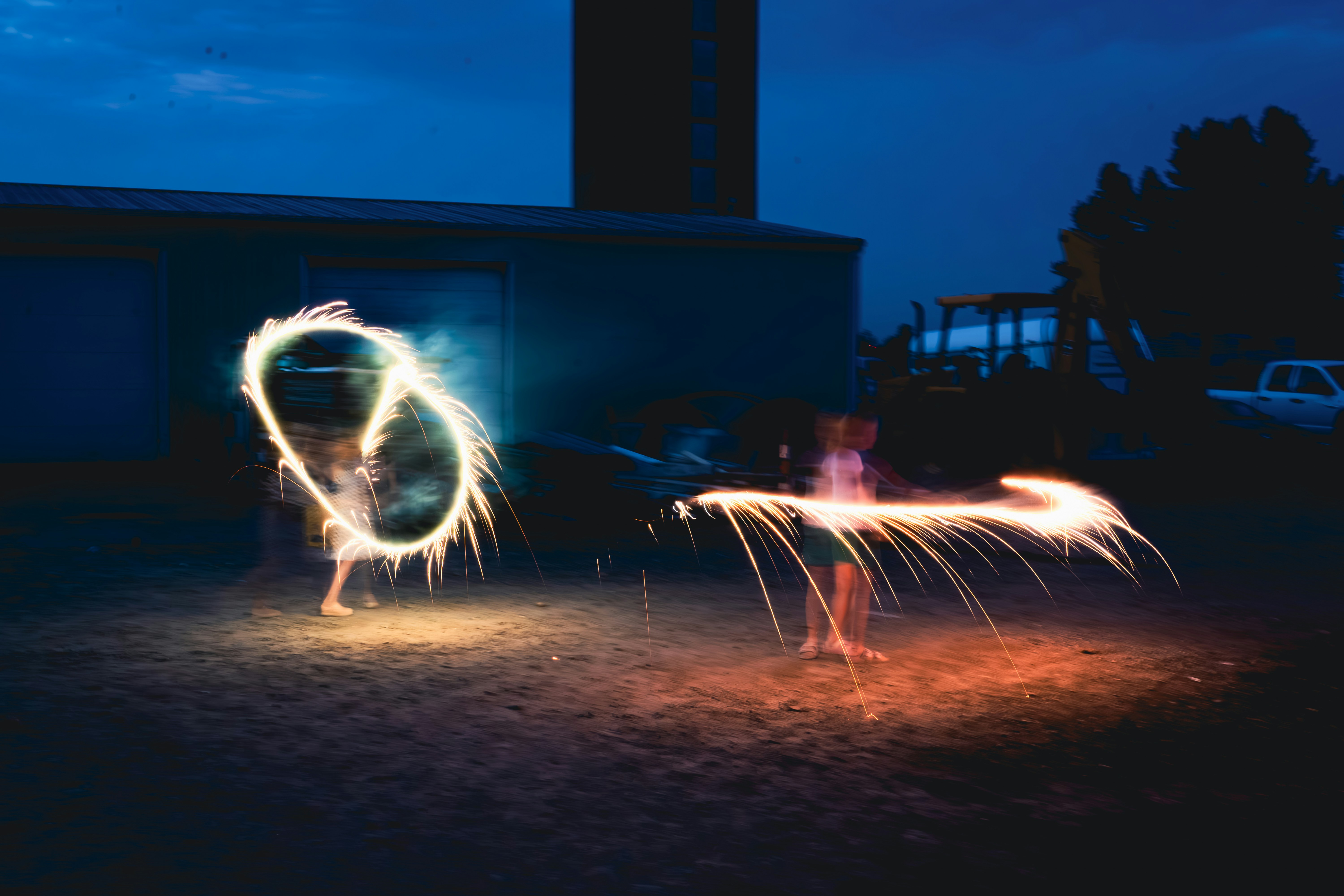 Orbital Sparks: Two Fireflies Tracing Light with Sparking Trails