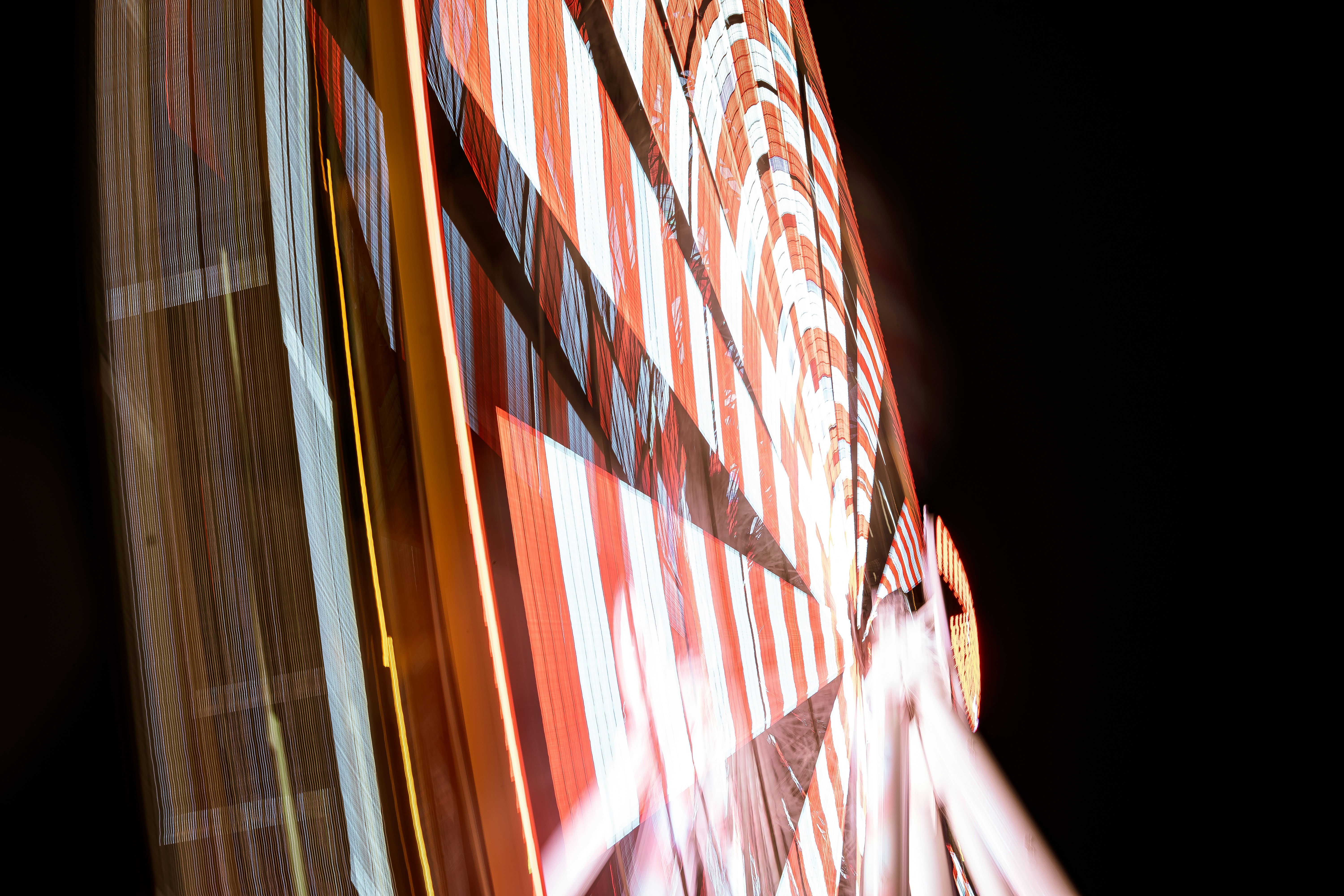 Neon Carousel Wake: Blurred Stripes at Night