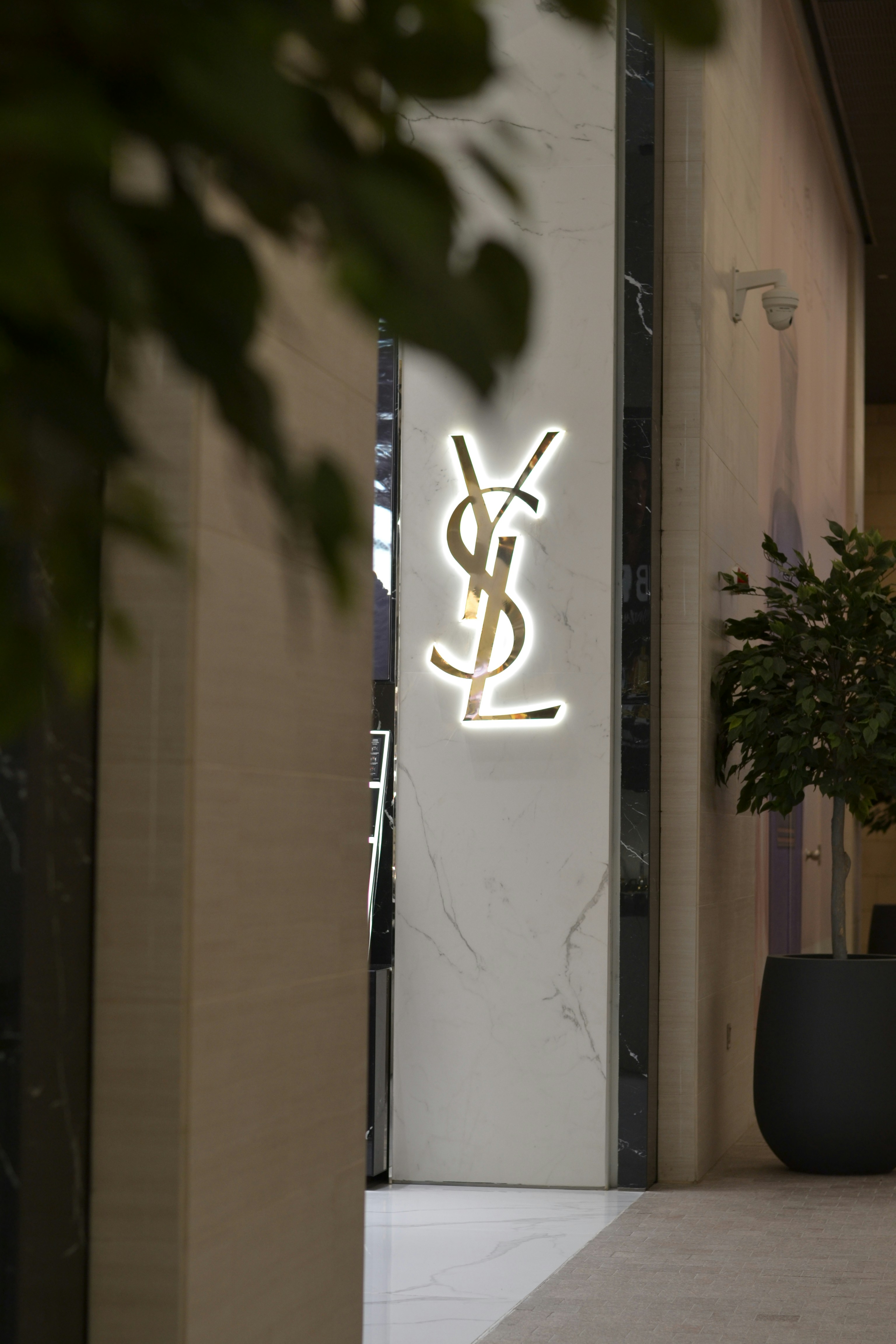 A door way with a sign that says ysl on it photo – Free Woman Image on ...