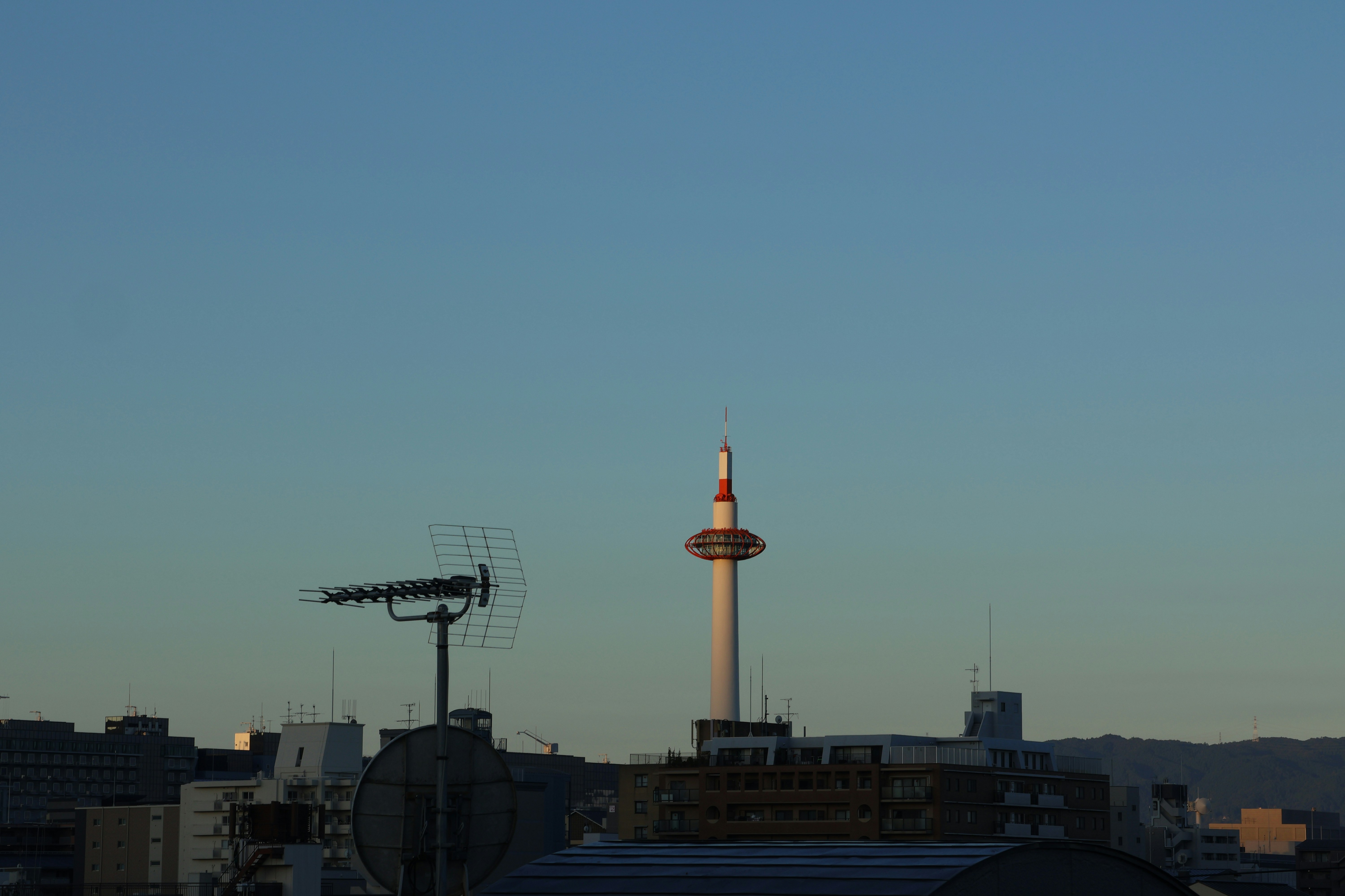 A plane flying over a city with tall buildings photo – Free Kyoto Image ...