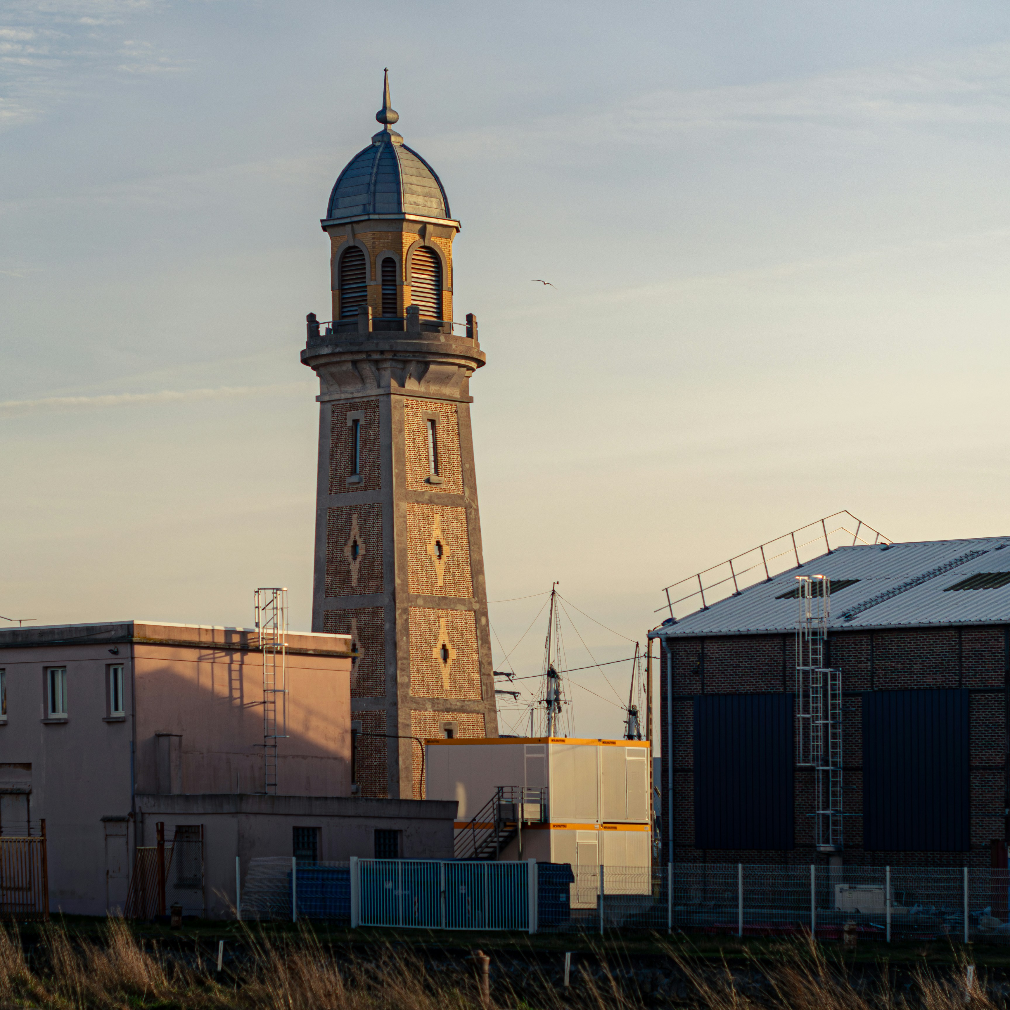 Beacon Tower at Golden Hour: A Quiet Harbor Silhouette