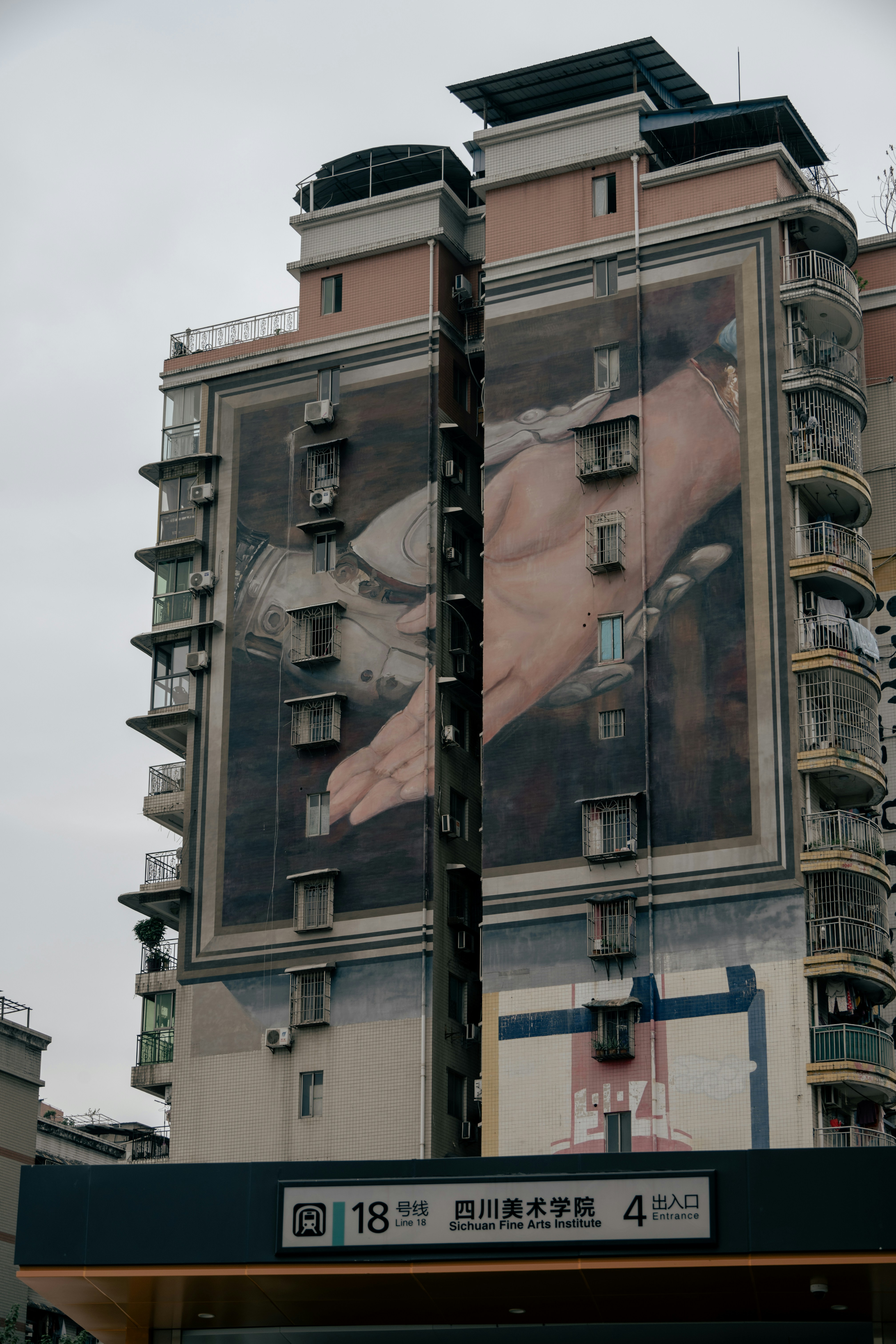 Two-Sided Portrait: A High-Rise Cloaked in Enormous Murals