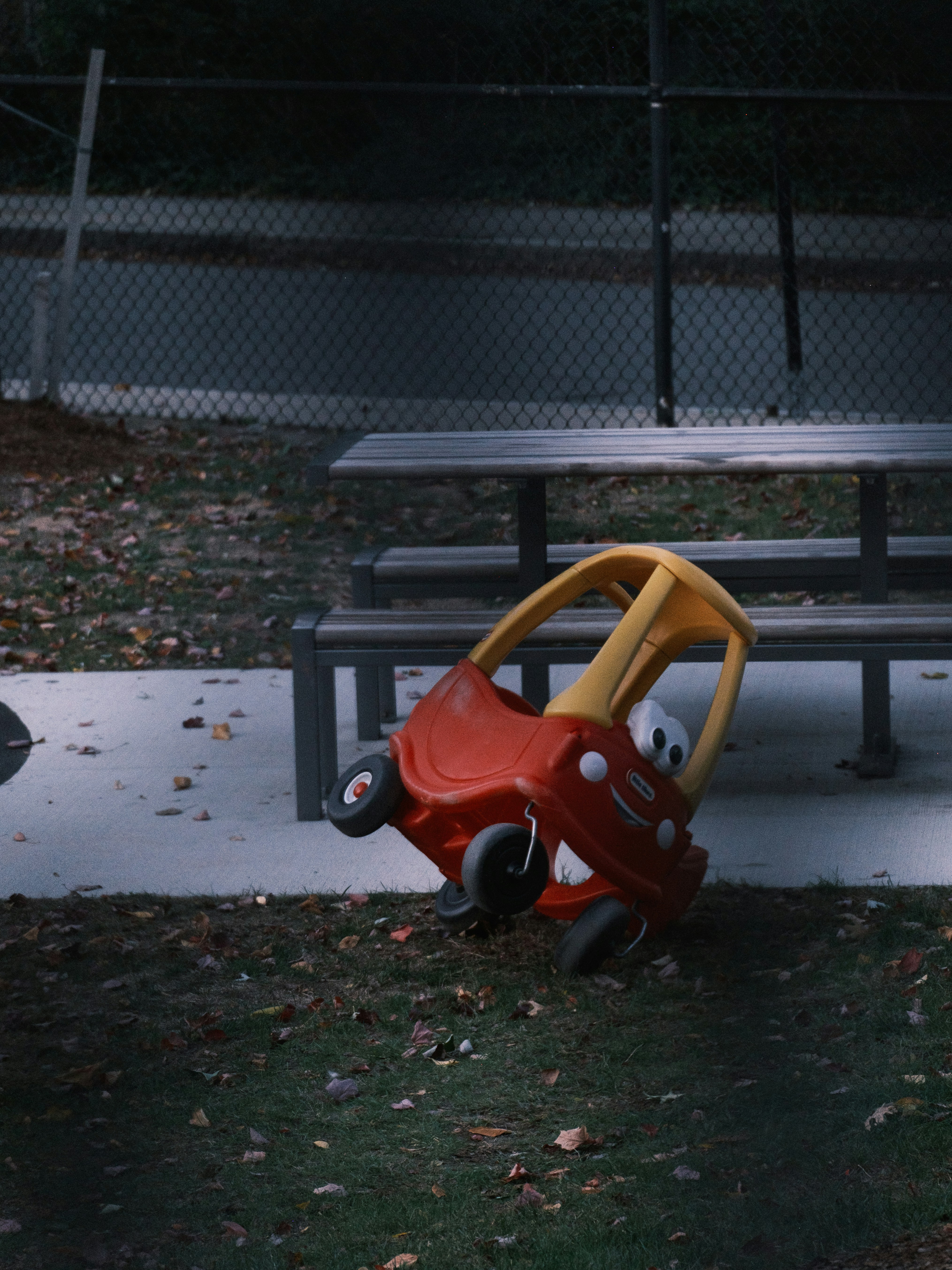 Dismayed Toy Car at Dusk: A Fallen Play Ground