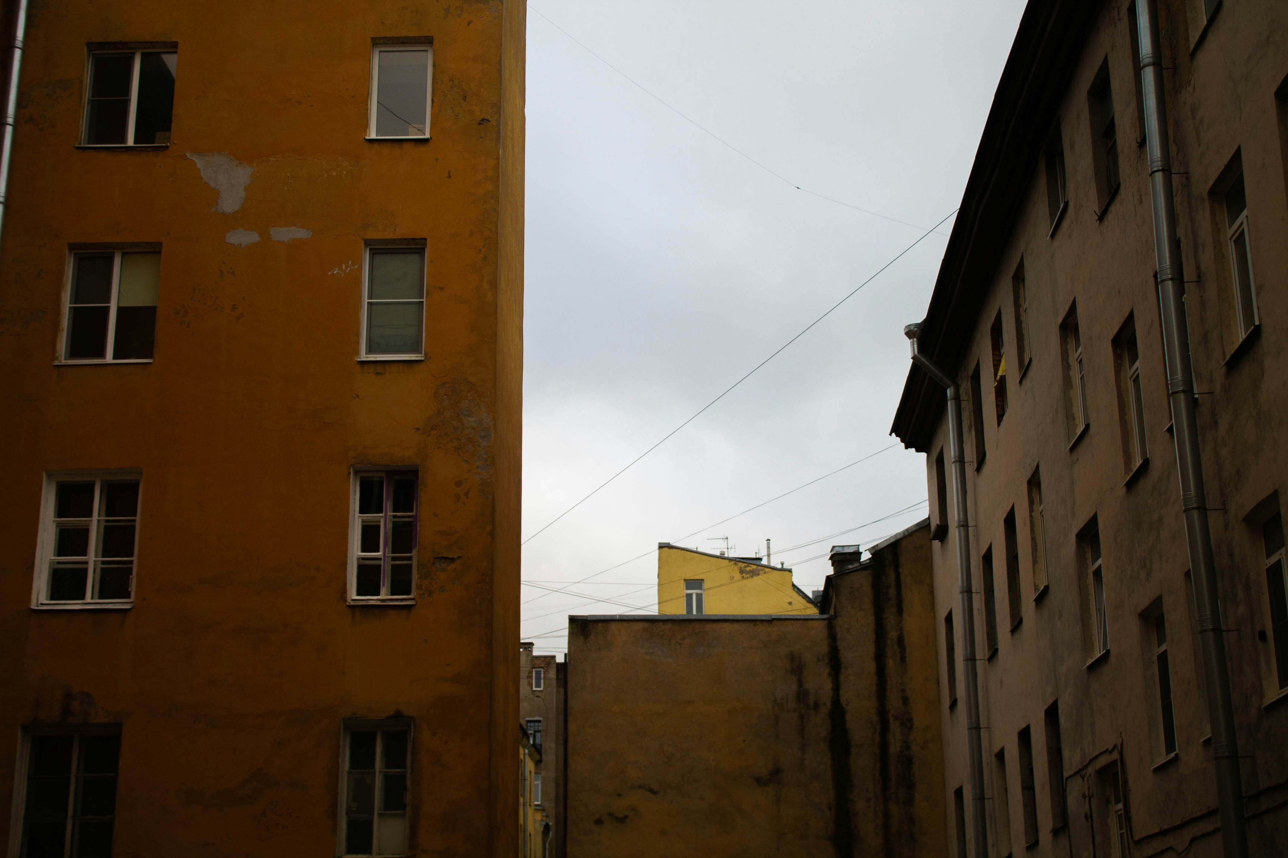 A tall yellow building sitting next to a tall yellow building photo ...