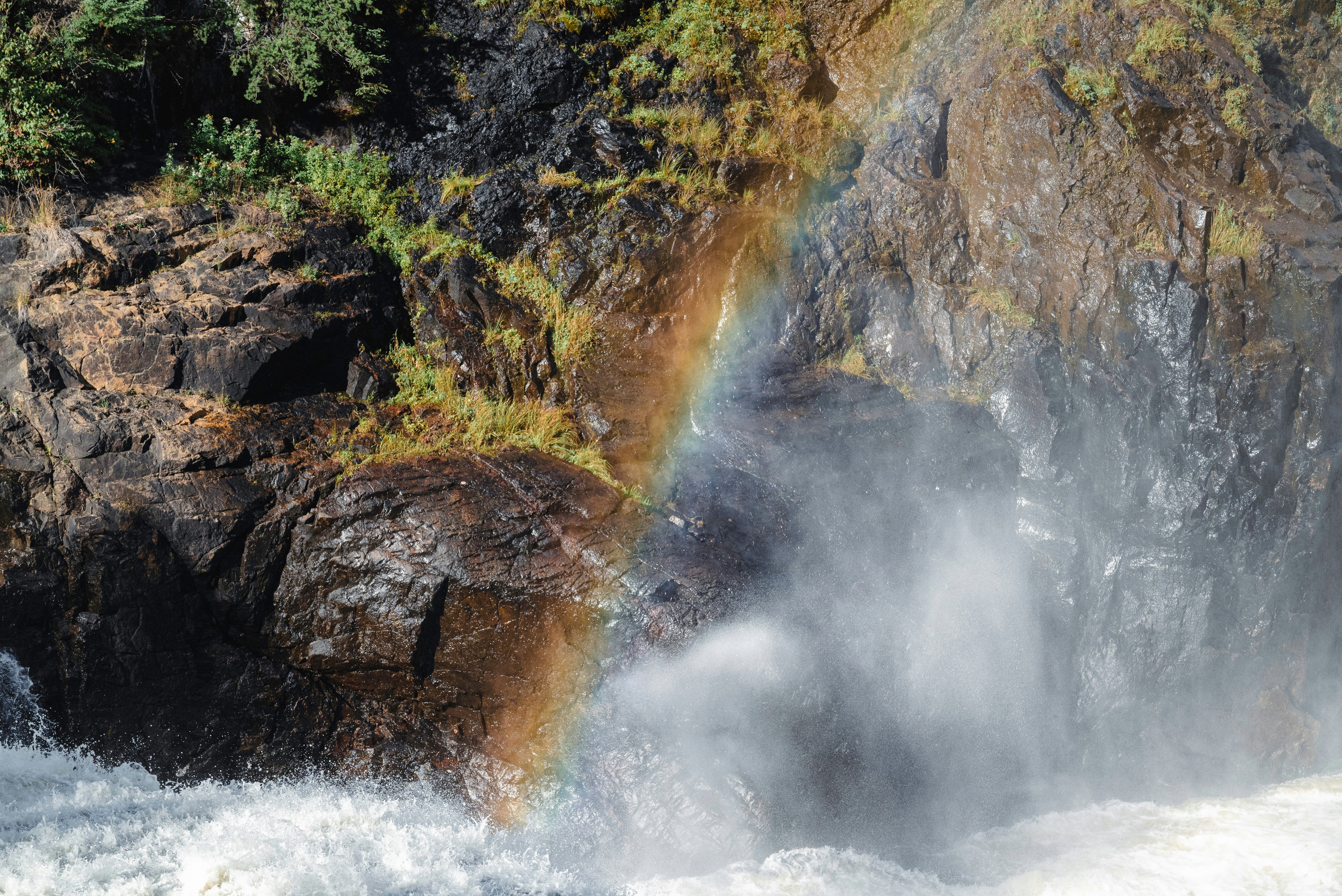 Waterfalls rainbow | A waterfall with a rainbow in the middle of it