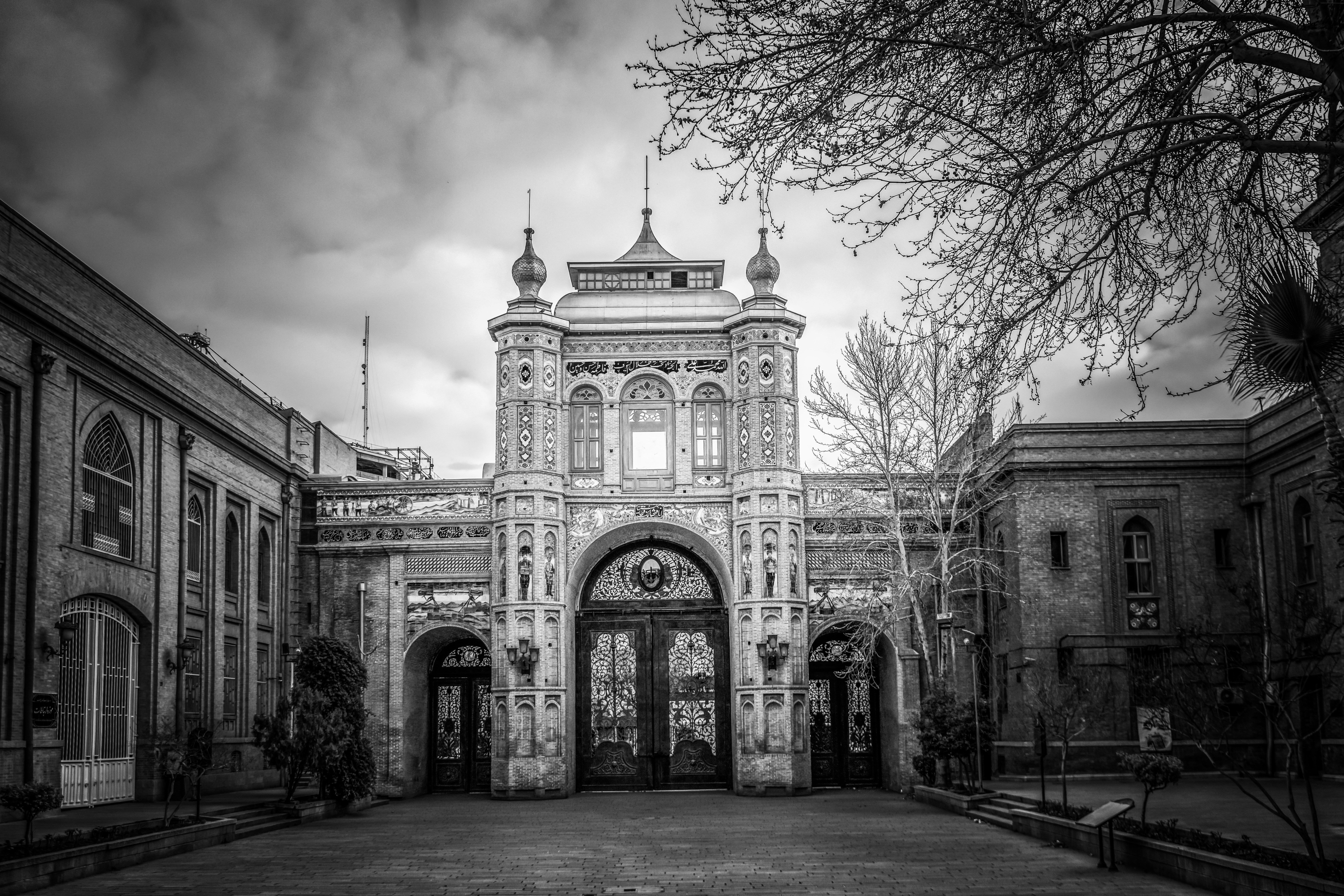 Symmetry in Stone: The Central Gate Amid a Quiet Brick Courtyard