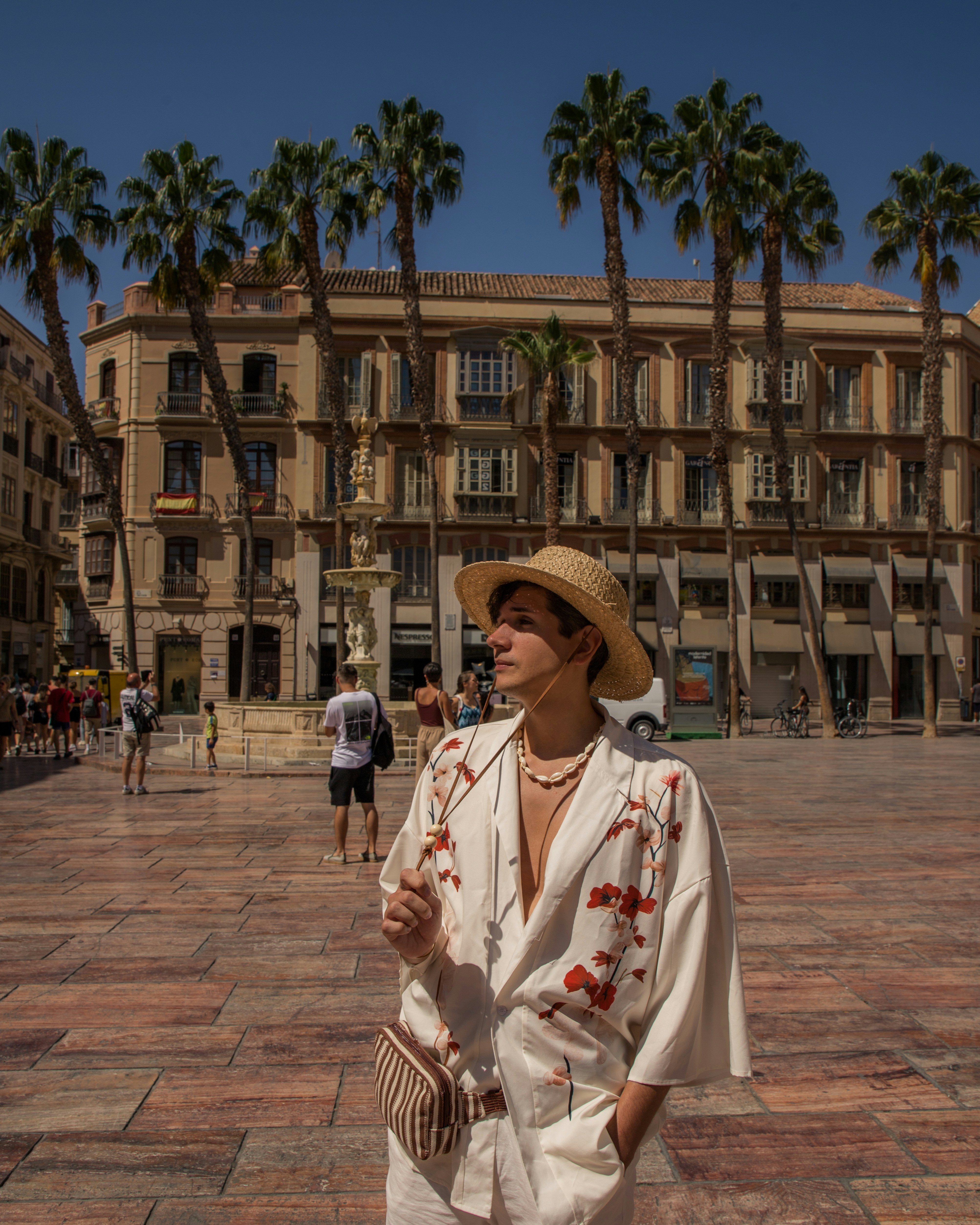 Straw Hat in the Plaza: A Palm-Fringed Portrait Among Sunlit Facades