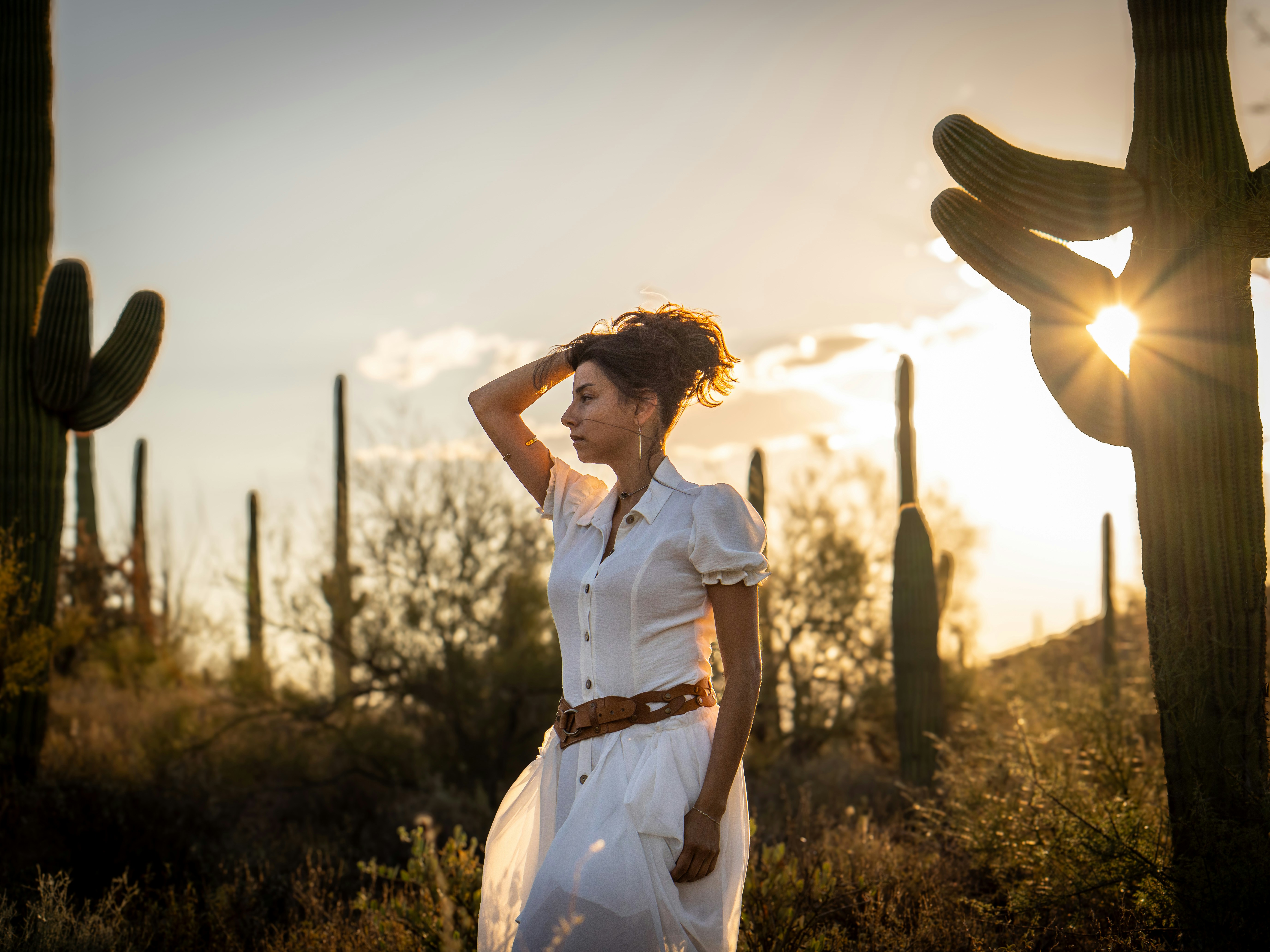 Desert Light: Sleeved white dress in sunset with towering saguaro silhouettes