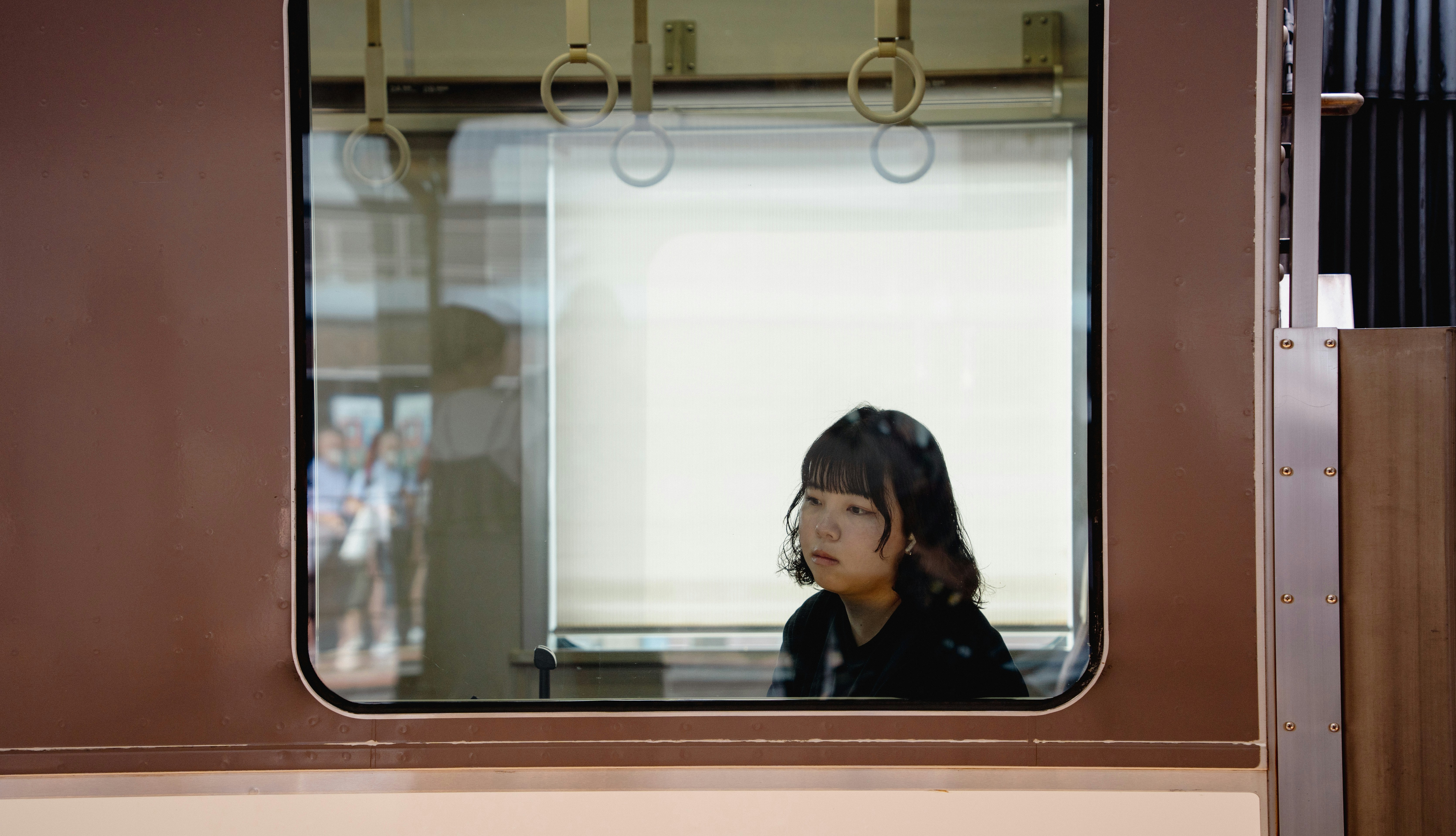 A woman looking out of a train window photo – Free Head Image on Unsplash