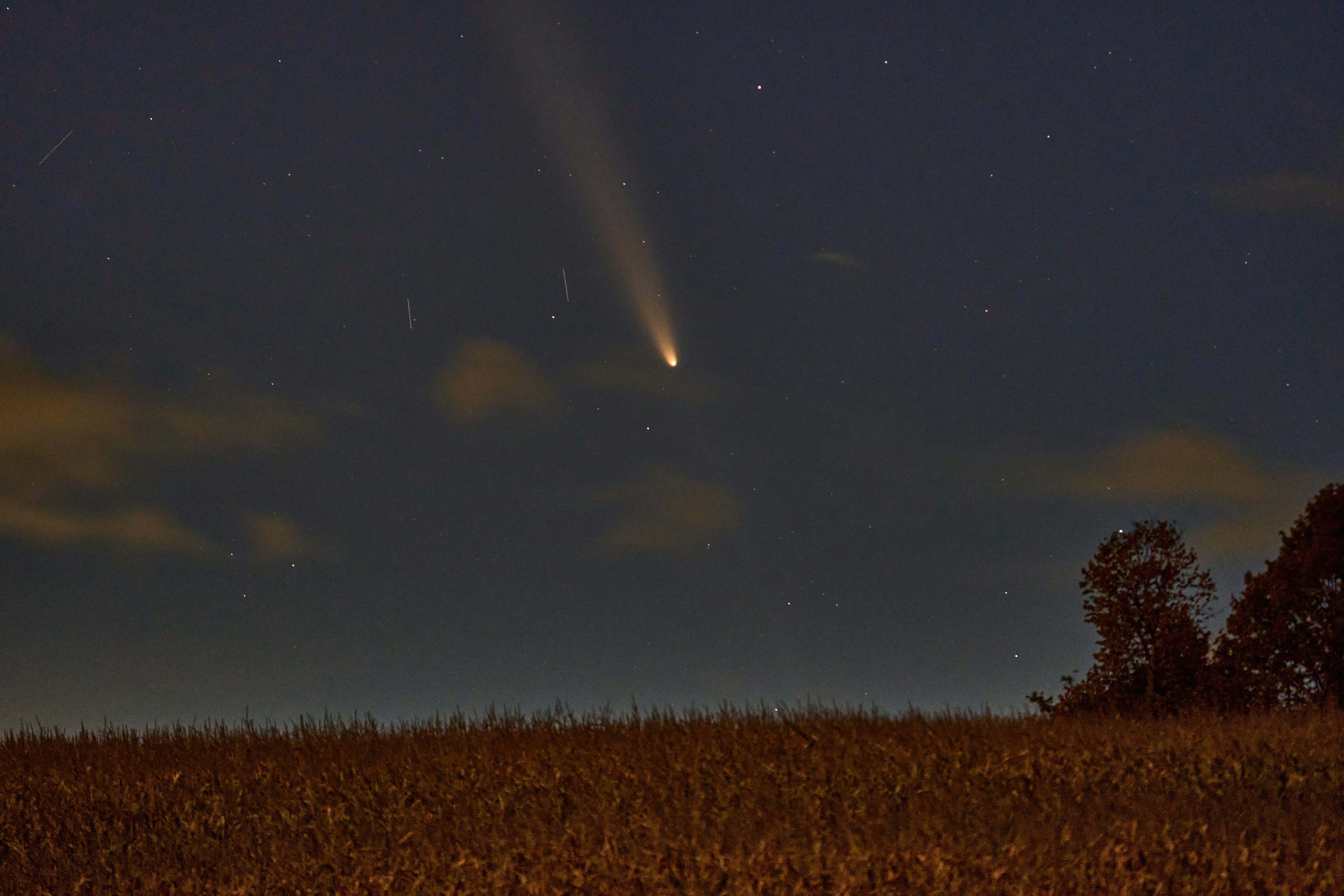 A rocket is flying in the sky above a field photo – Free Ontario Image ...