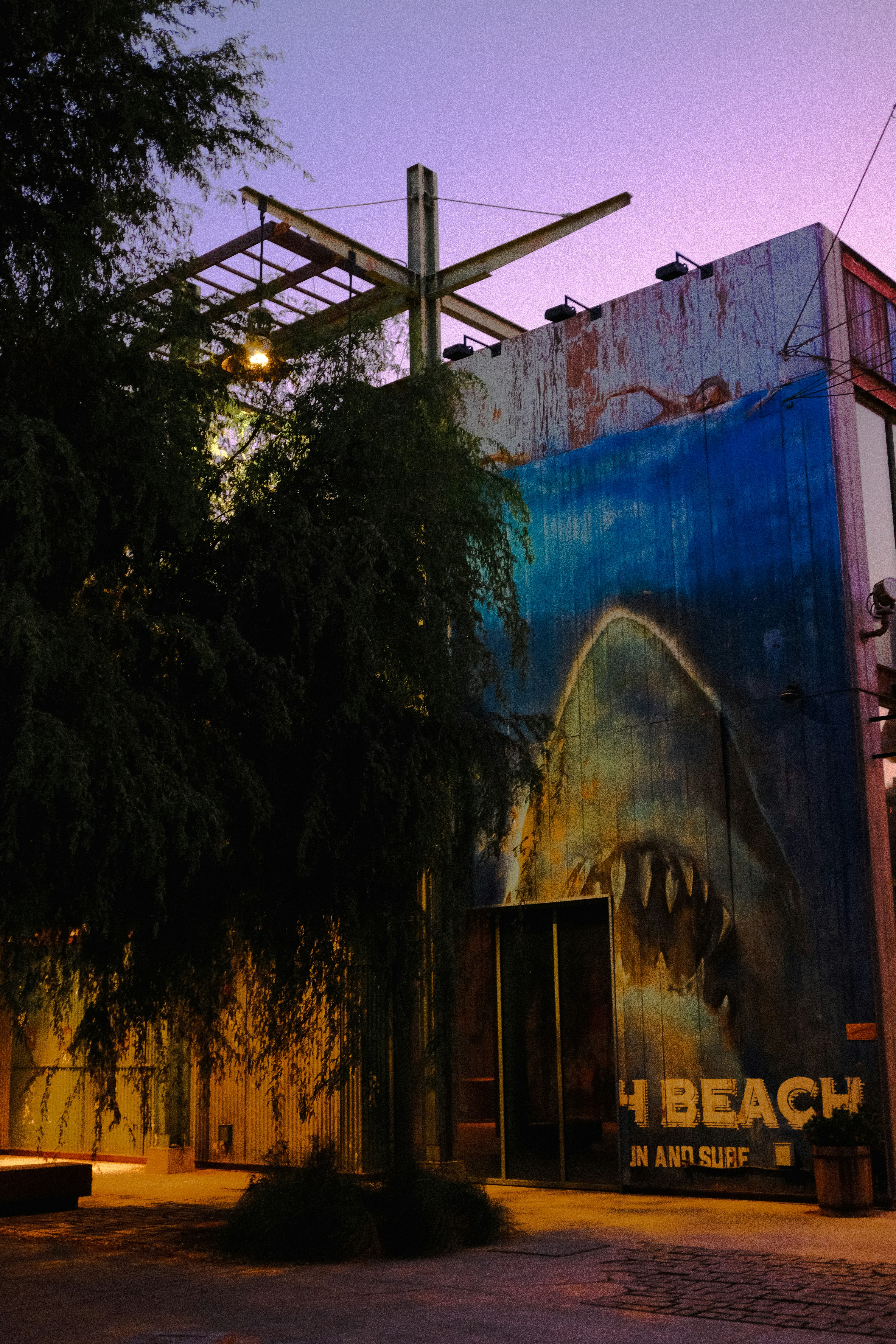 Dusk Shark on a Weathered Blue Wall: A Coastal Graffiti Mural