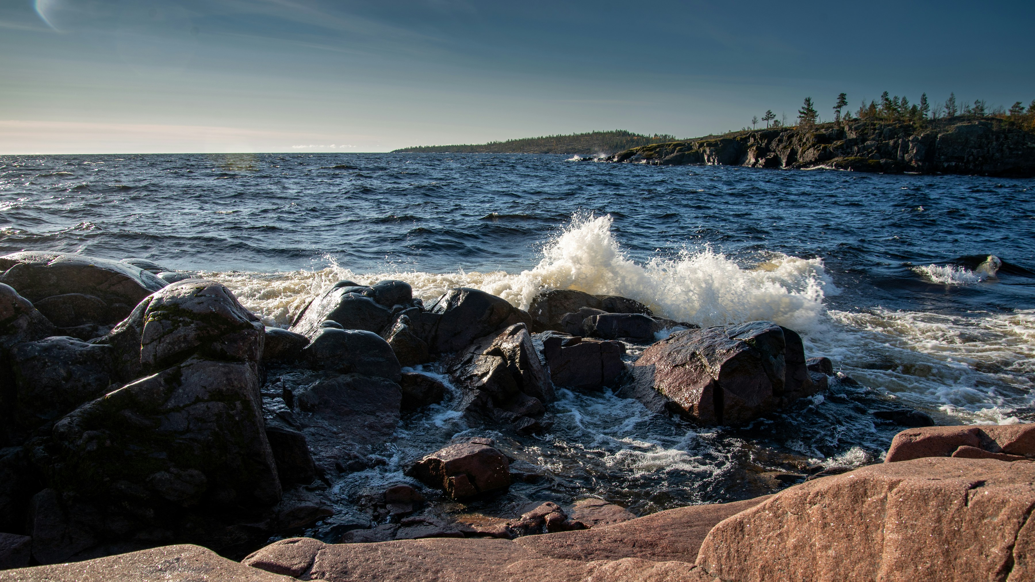A rocky shore with waves crashing against the rocks photo – Free Rock ...