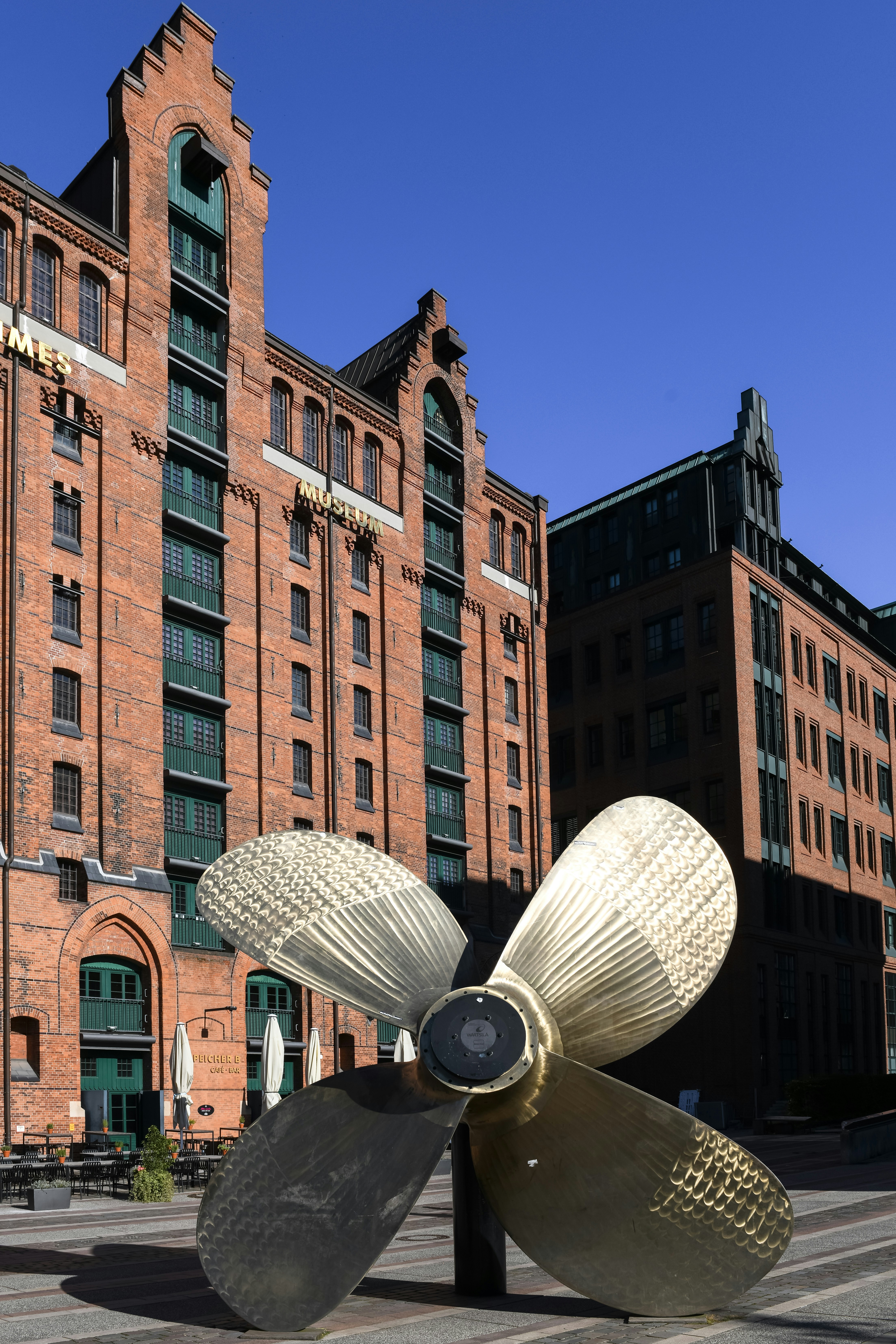 A sculpture of a propeller in front of a building photo – Free Hamburg ...