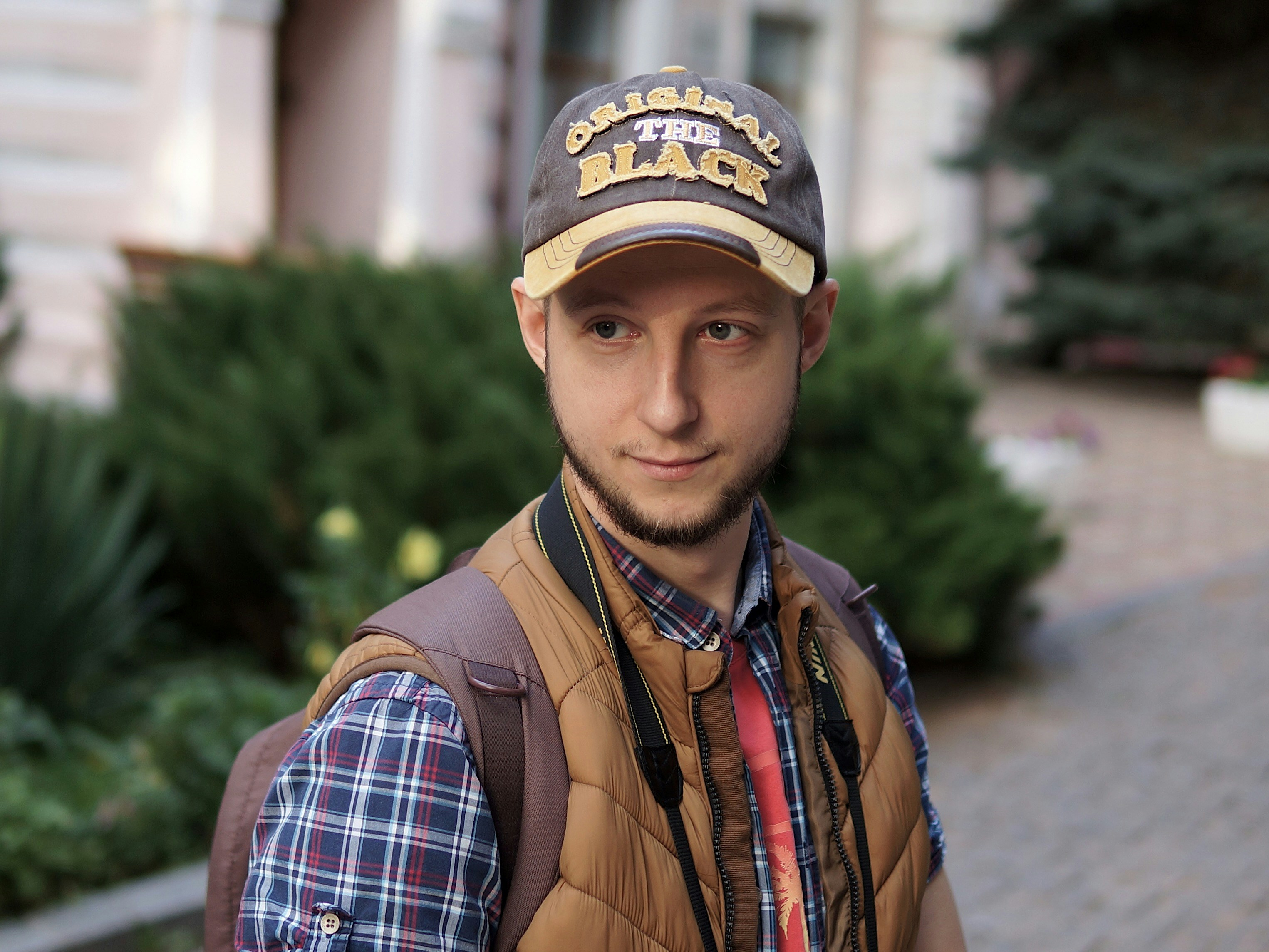 Plaid-Clad Traveler in a Quiet Courtyard