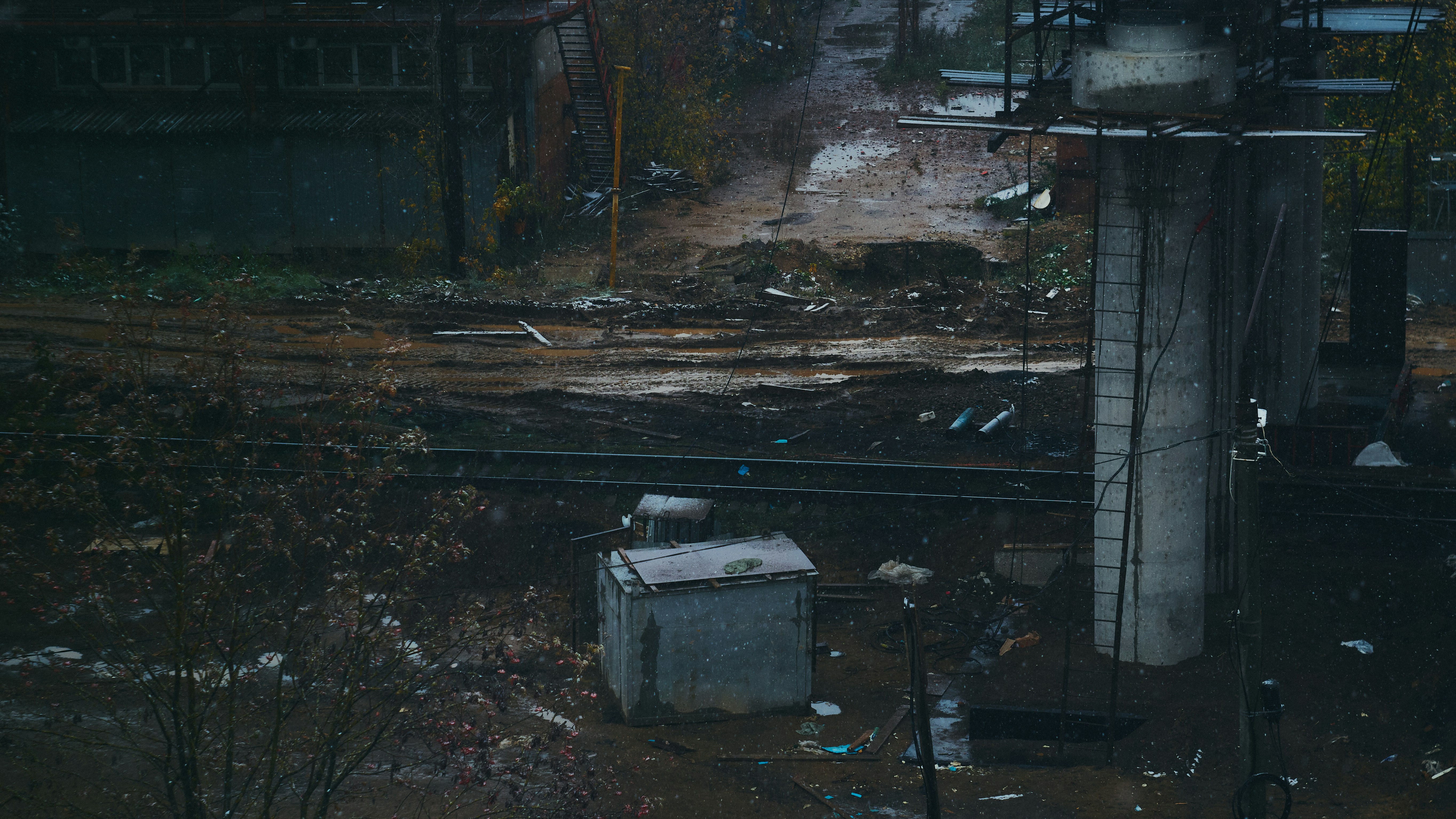 Rain-Kissed Utilities: A Dim Industrial Yard Under Diffuse Light