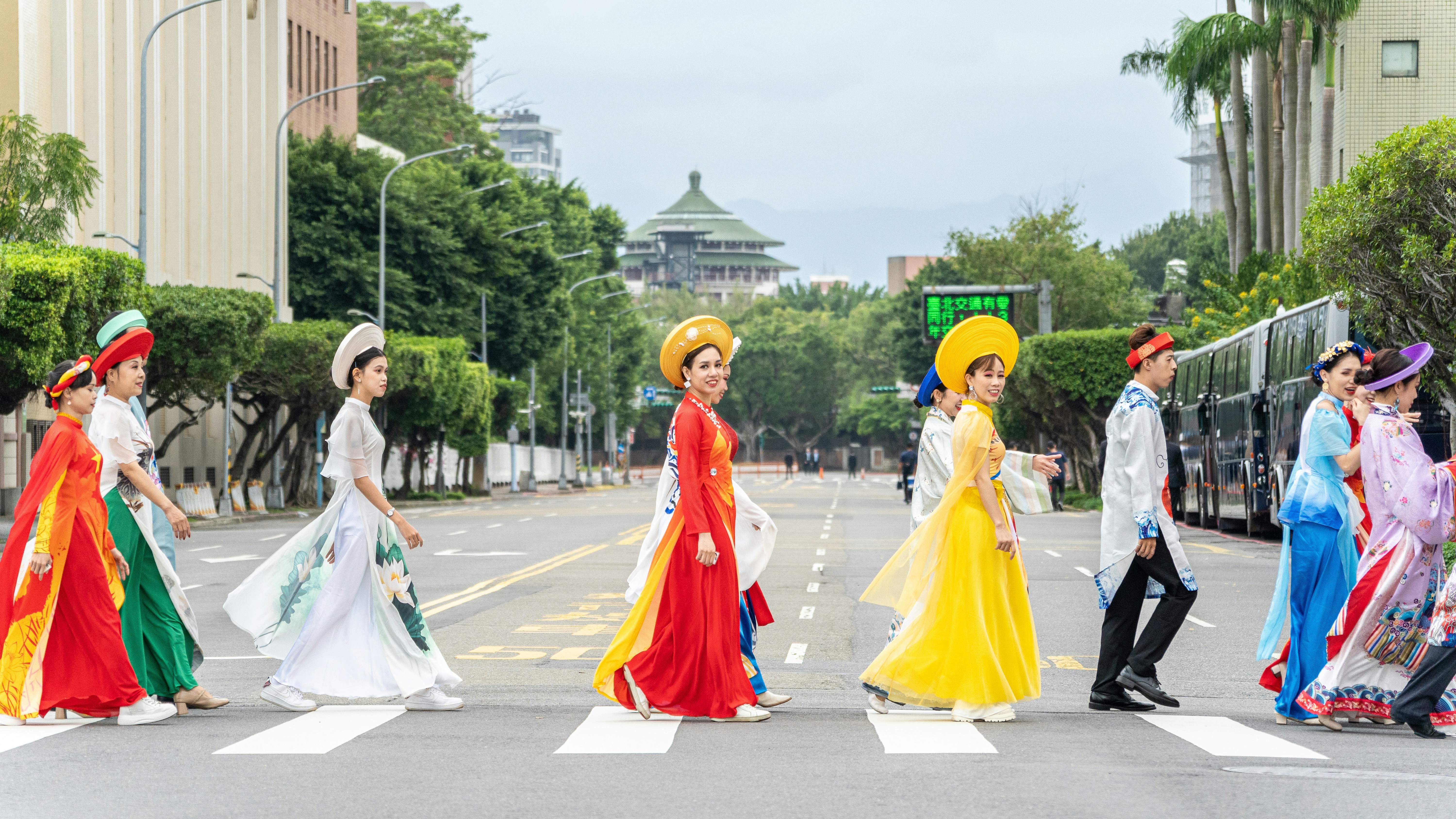 Ao Dai Parade: Colorful Threads Crossing a City Street