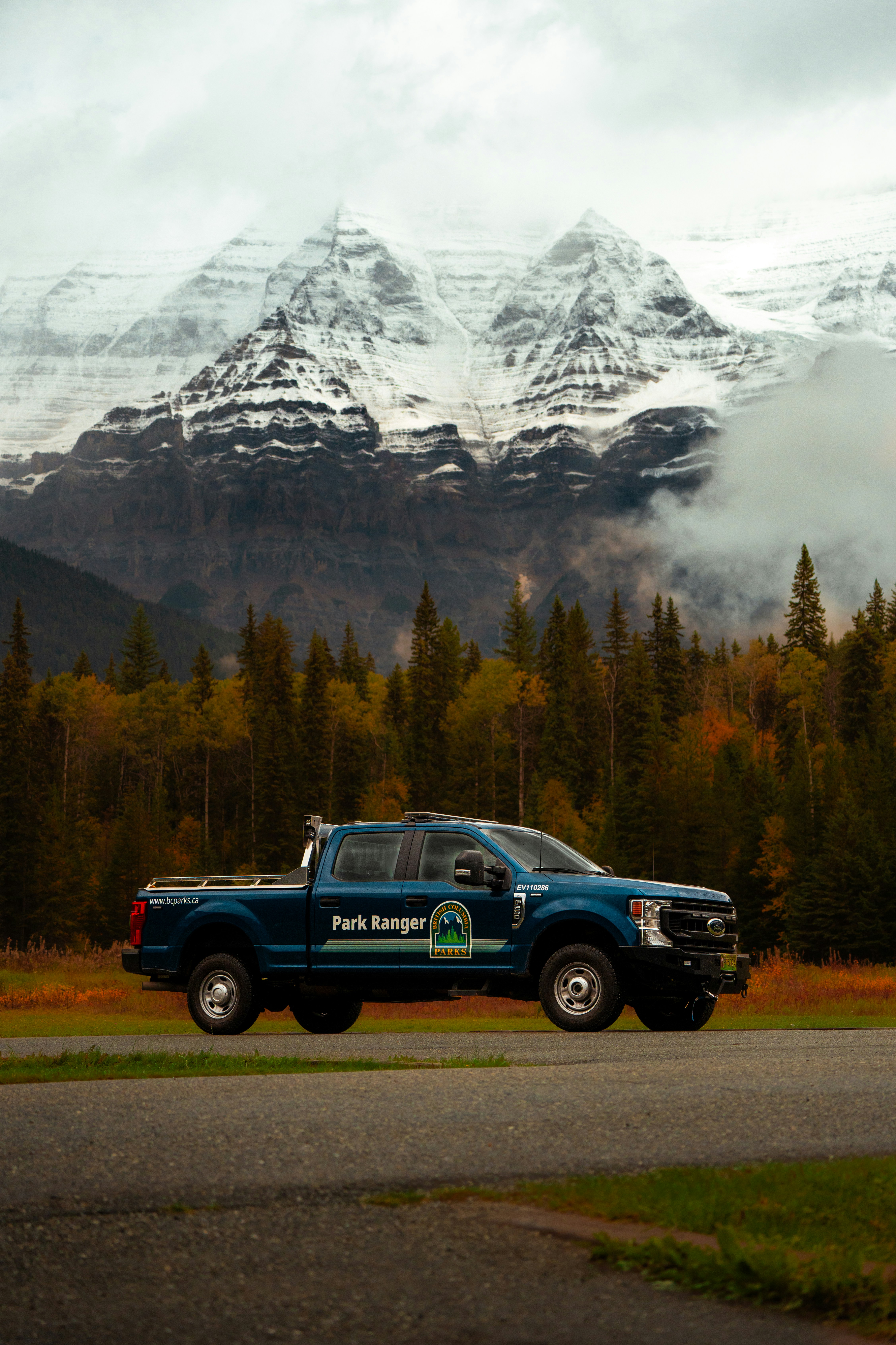 Park Ranger Pickup Stalwart Before Snow-Capped Peaks