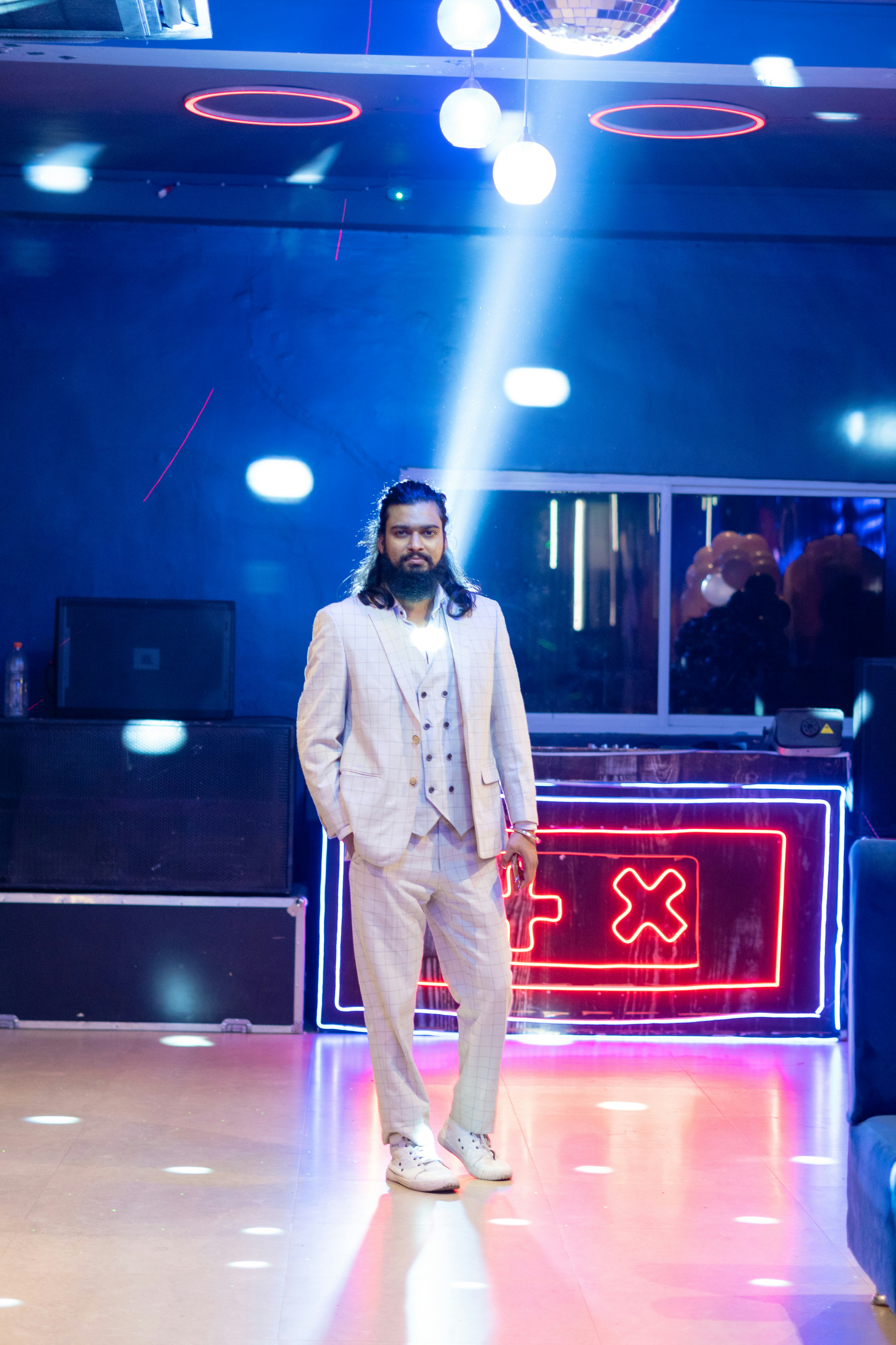 Laser-lit lounge: a dapper guest anchors the neon glow