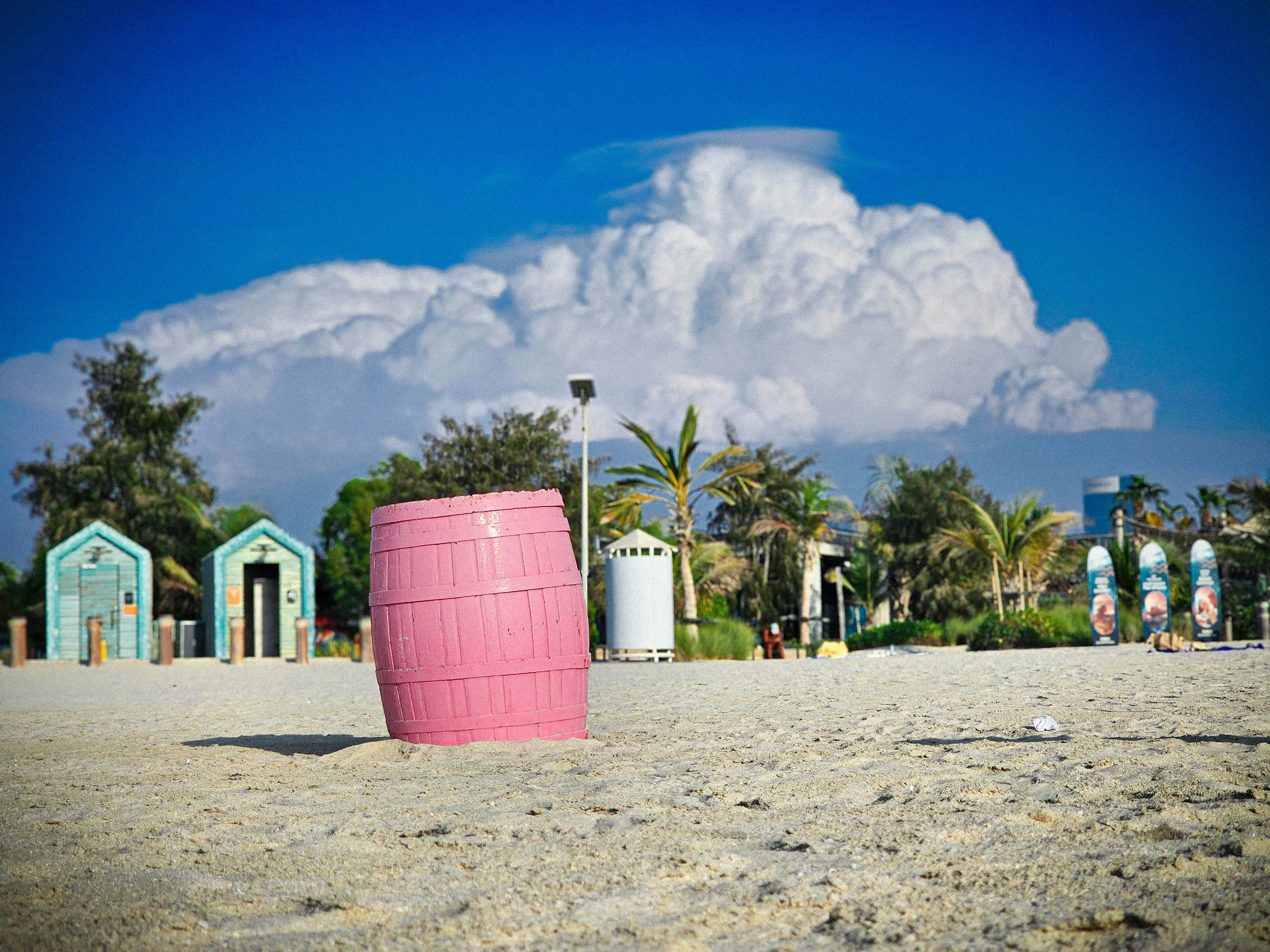 A pink barrel sitting on top of a sandy beach photo – Free Dubai ...