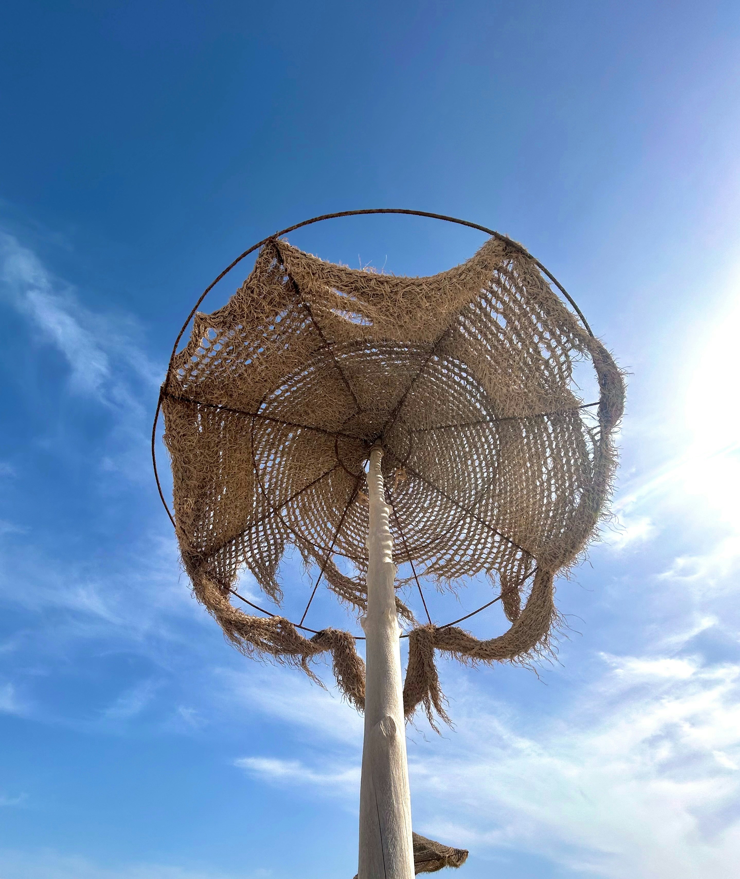 A large metal object sitting on top of a sandy beach