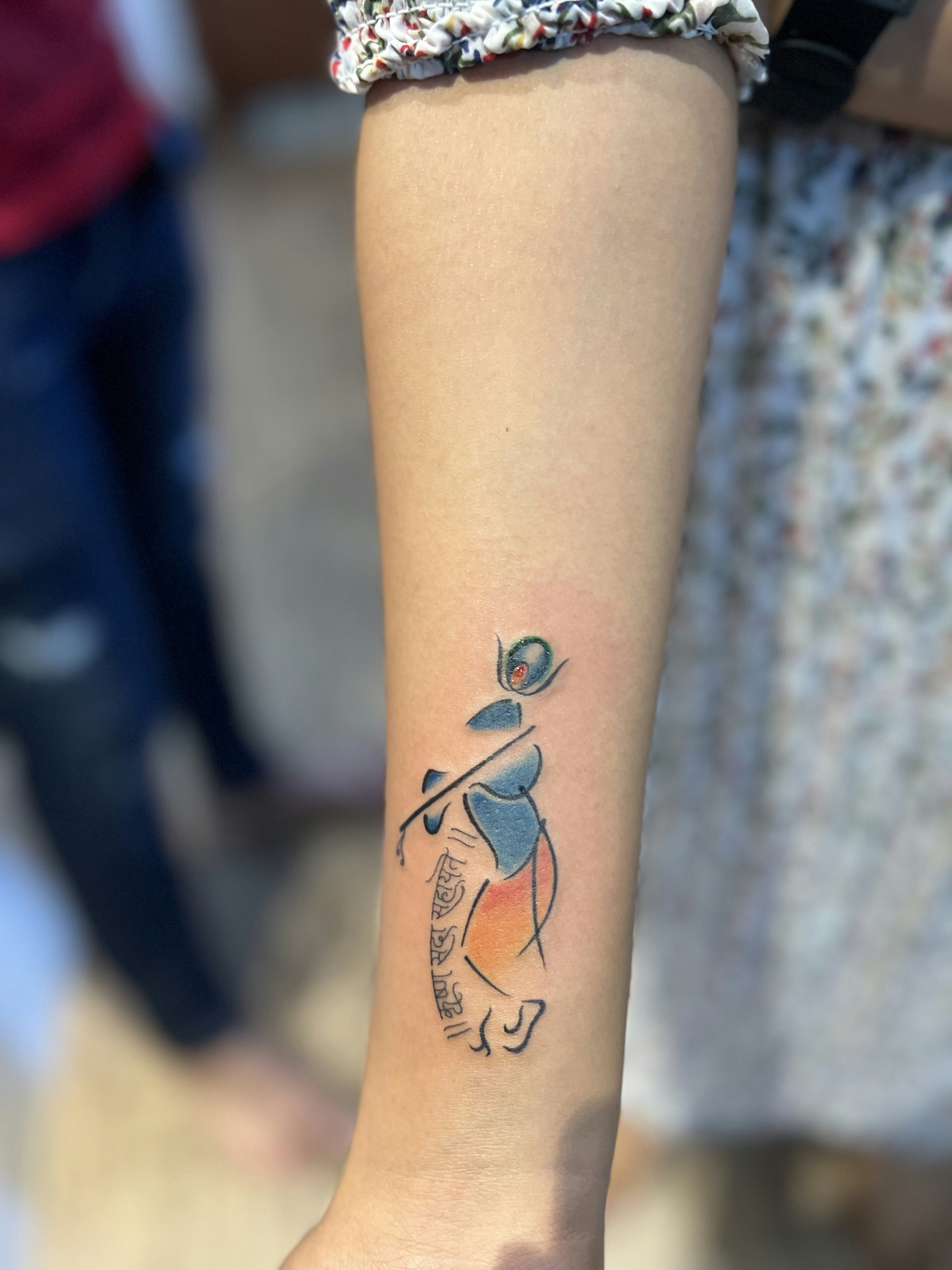 Sunlit Script: A Geometric Tattoo Anchored on a Forearm