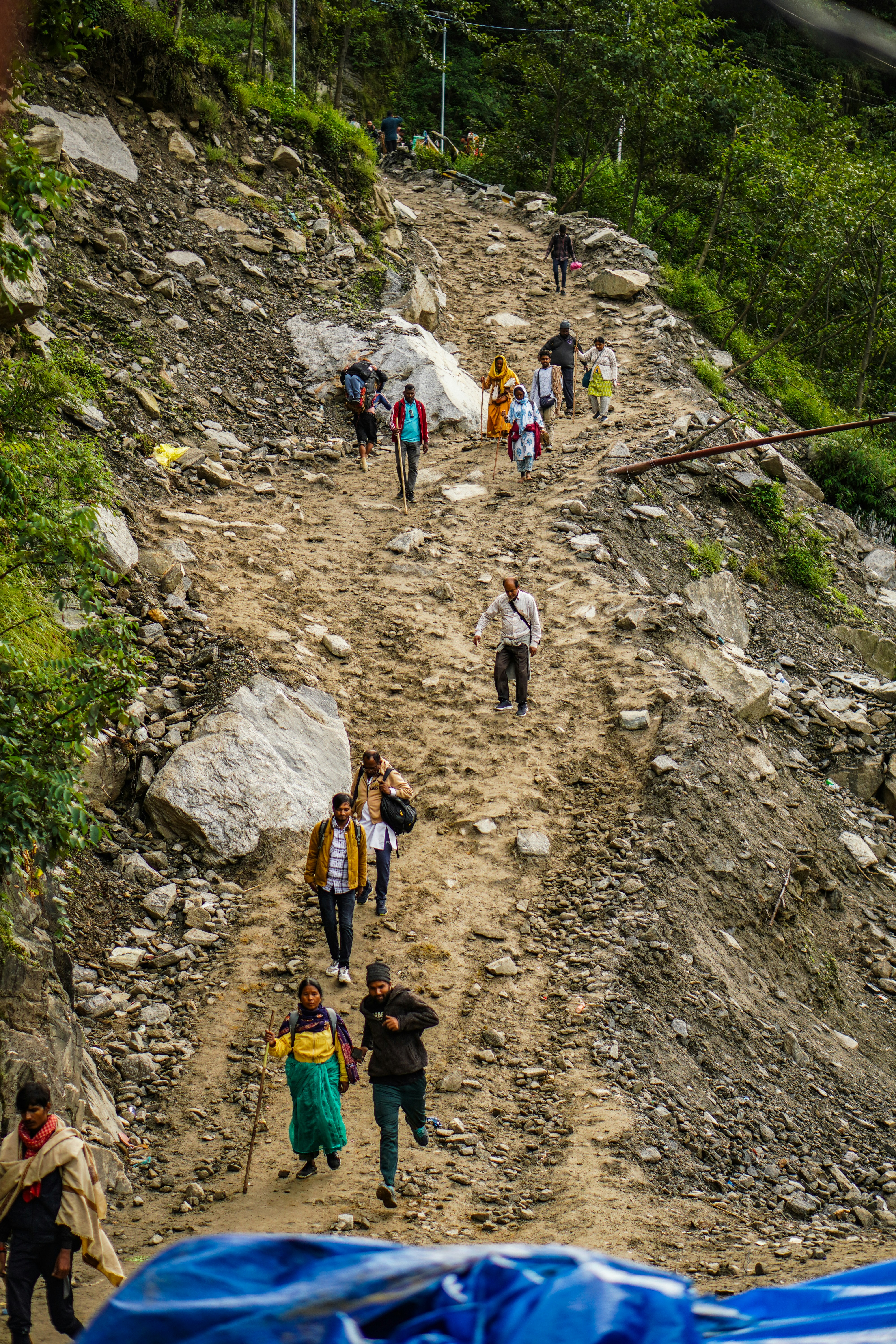 A group of people walking up a rocky hill photo – Free Woman Image on ...