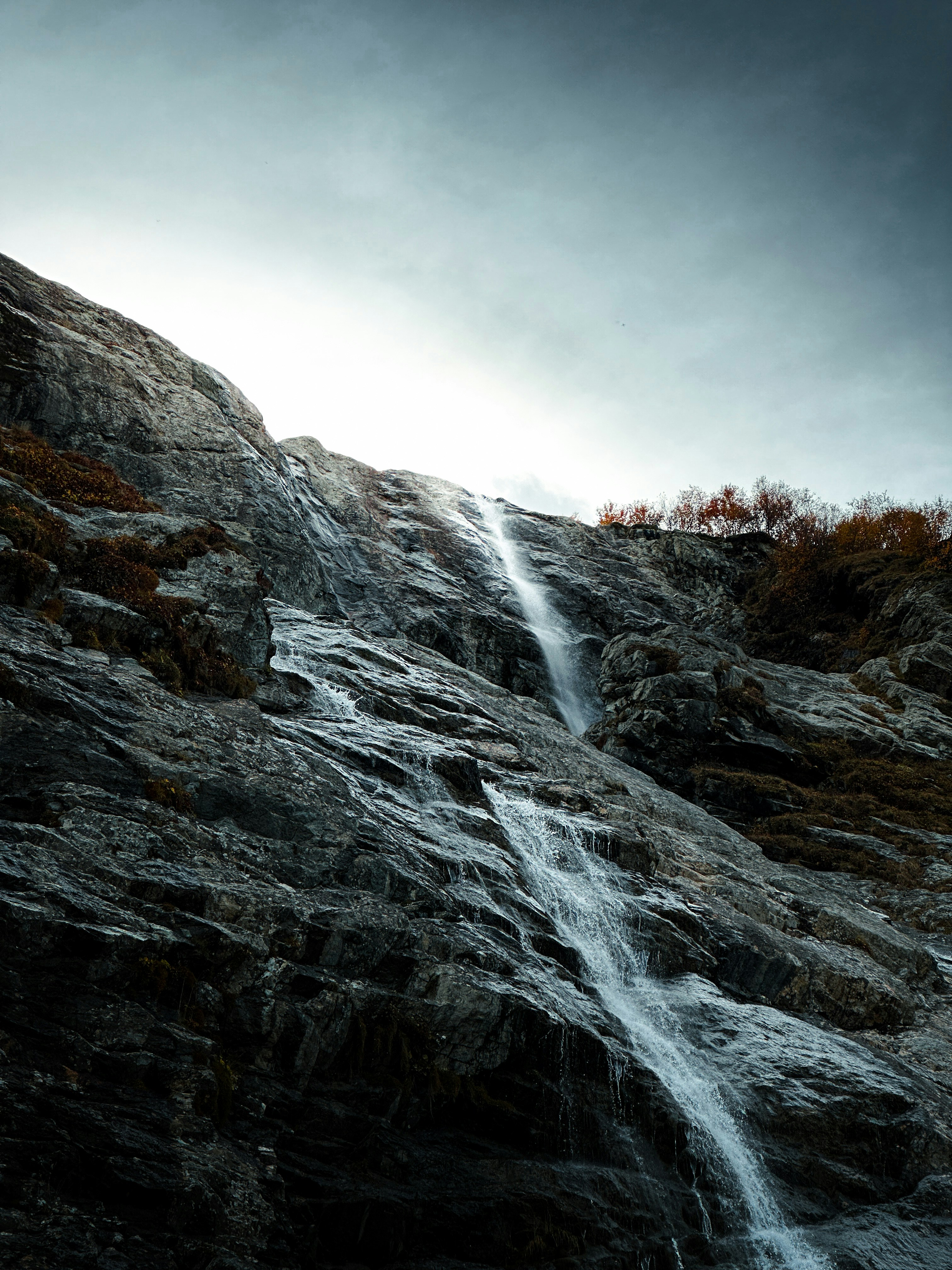 A very tall waterfall with a sky background photo – Free Waterfall ...