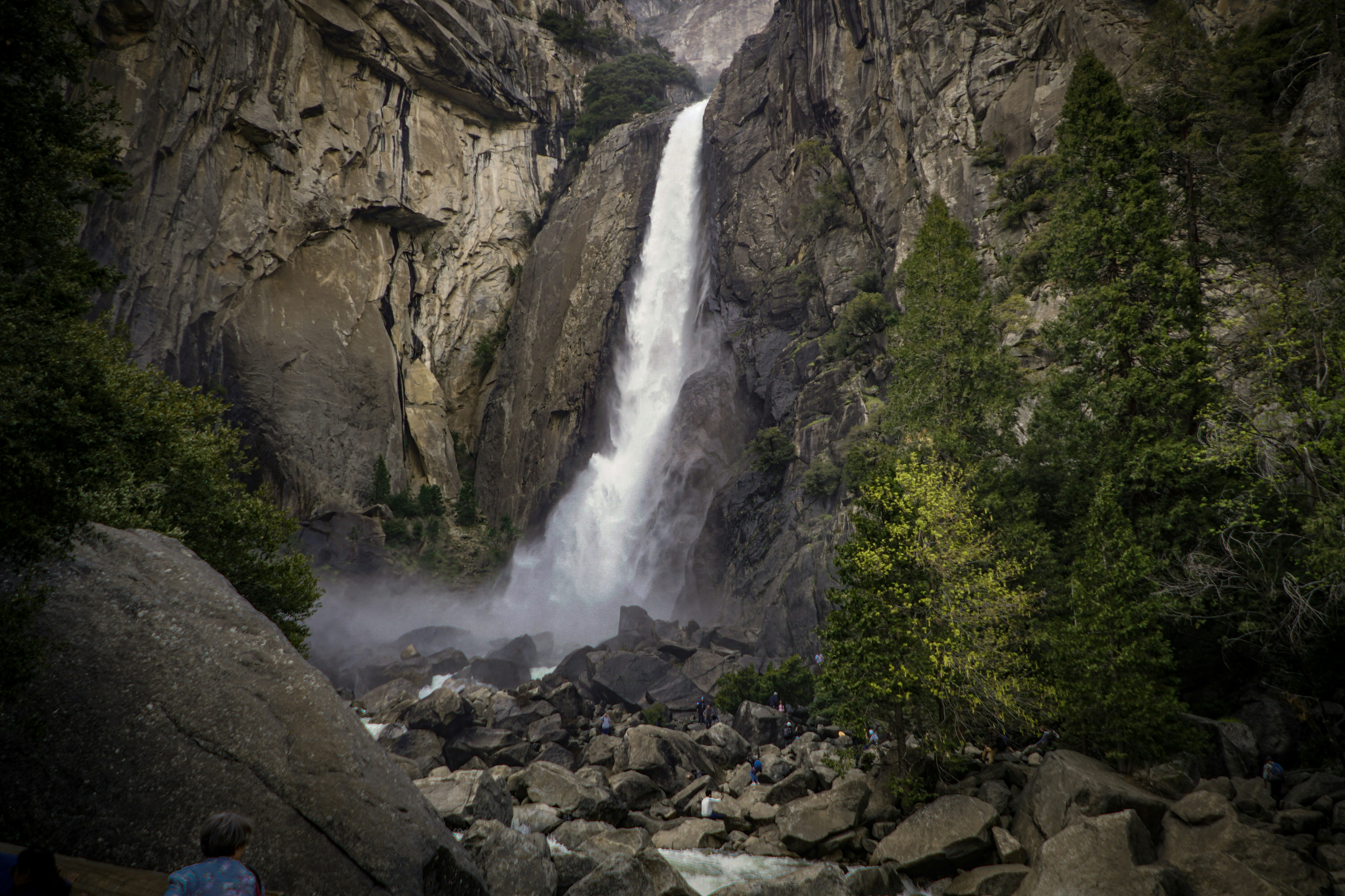 A man standing in front of a waterfall photo – Free Rock Image on Unsplash