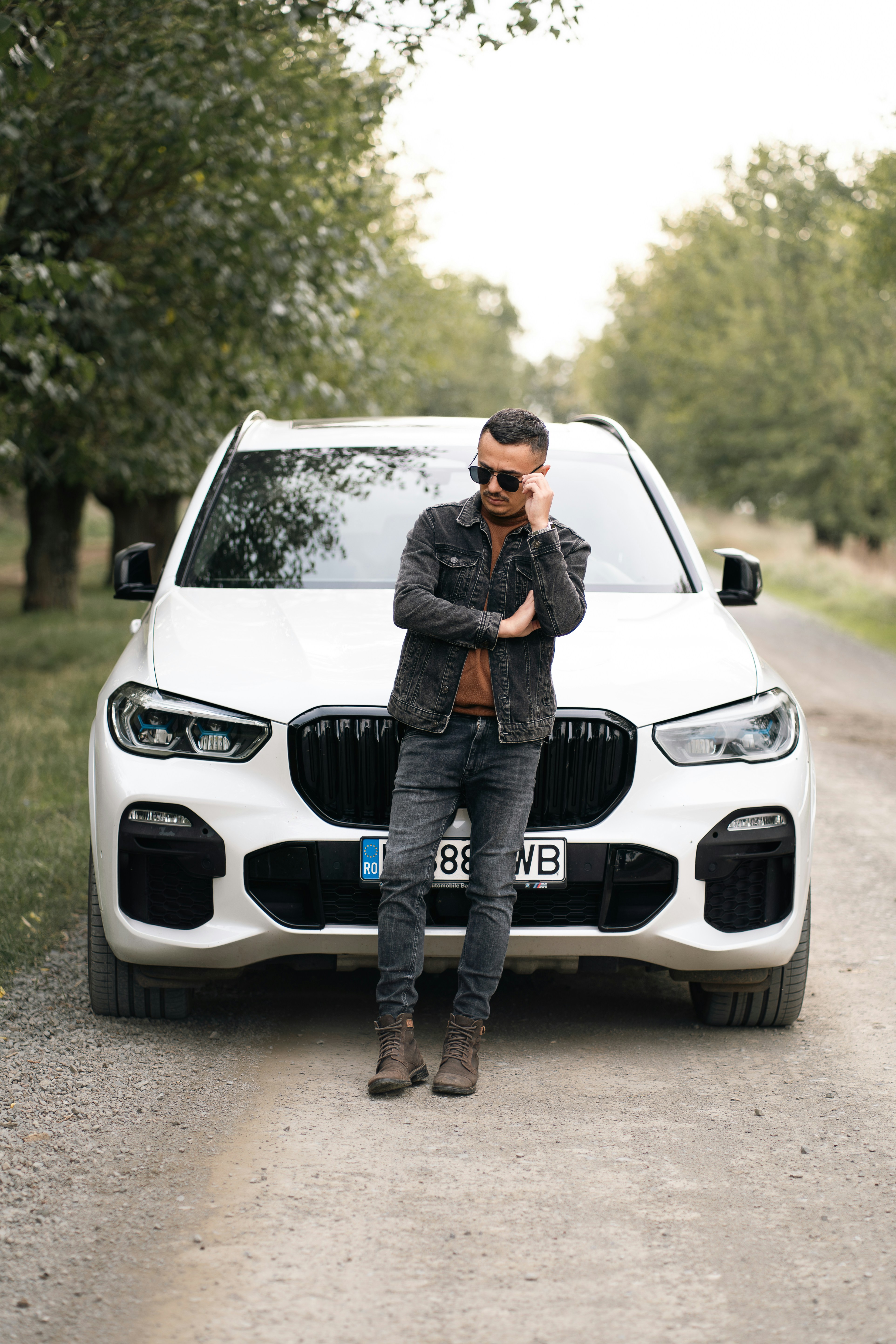 Pilot Pose: A Confident Moment in Front of a White SUV