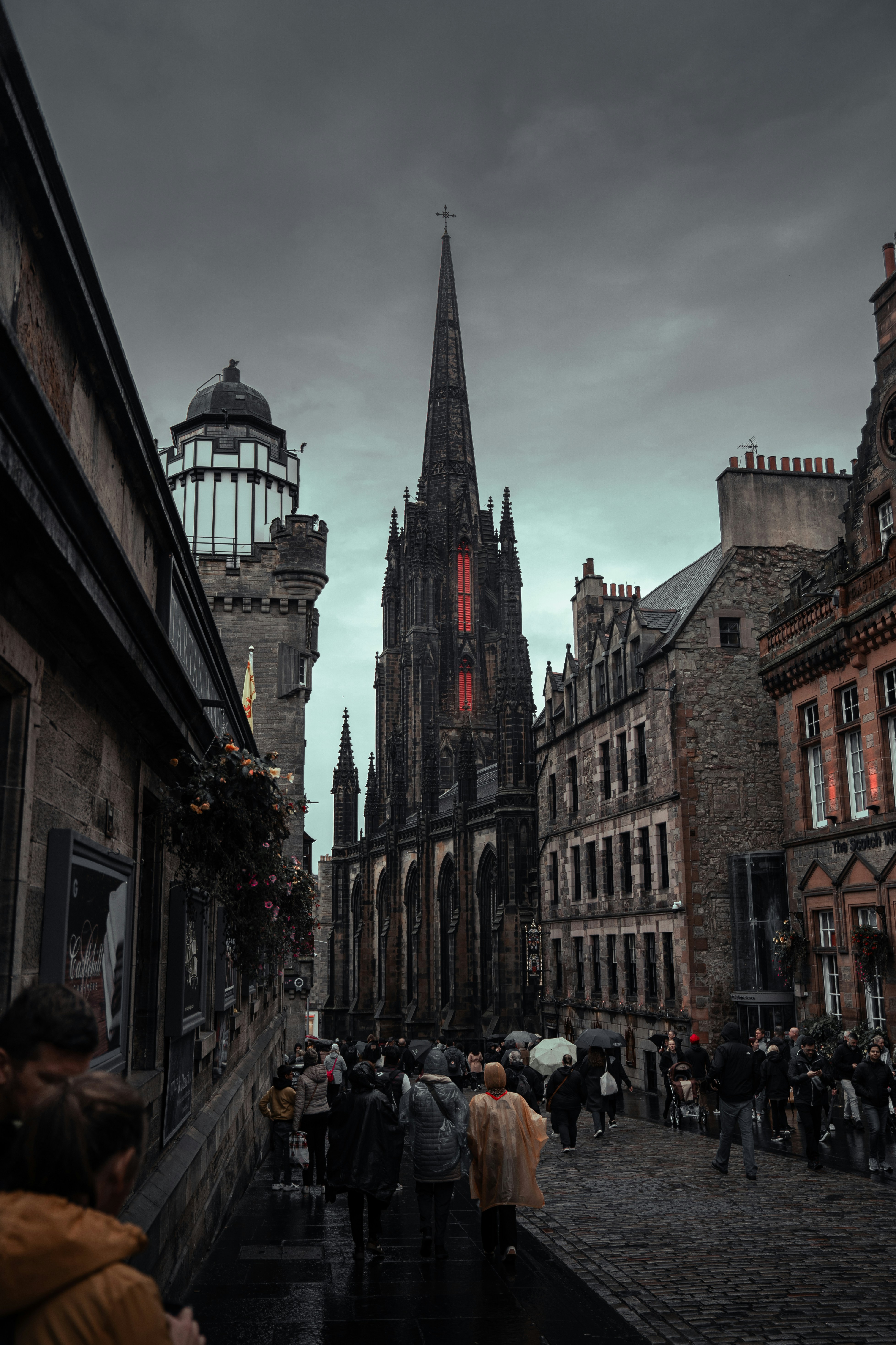 Gothic Spire Rising Over a Crowded Cobblestone Street