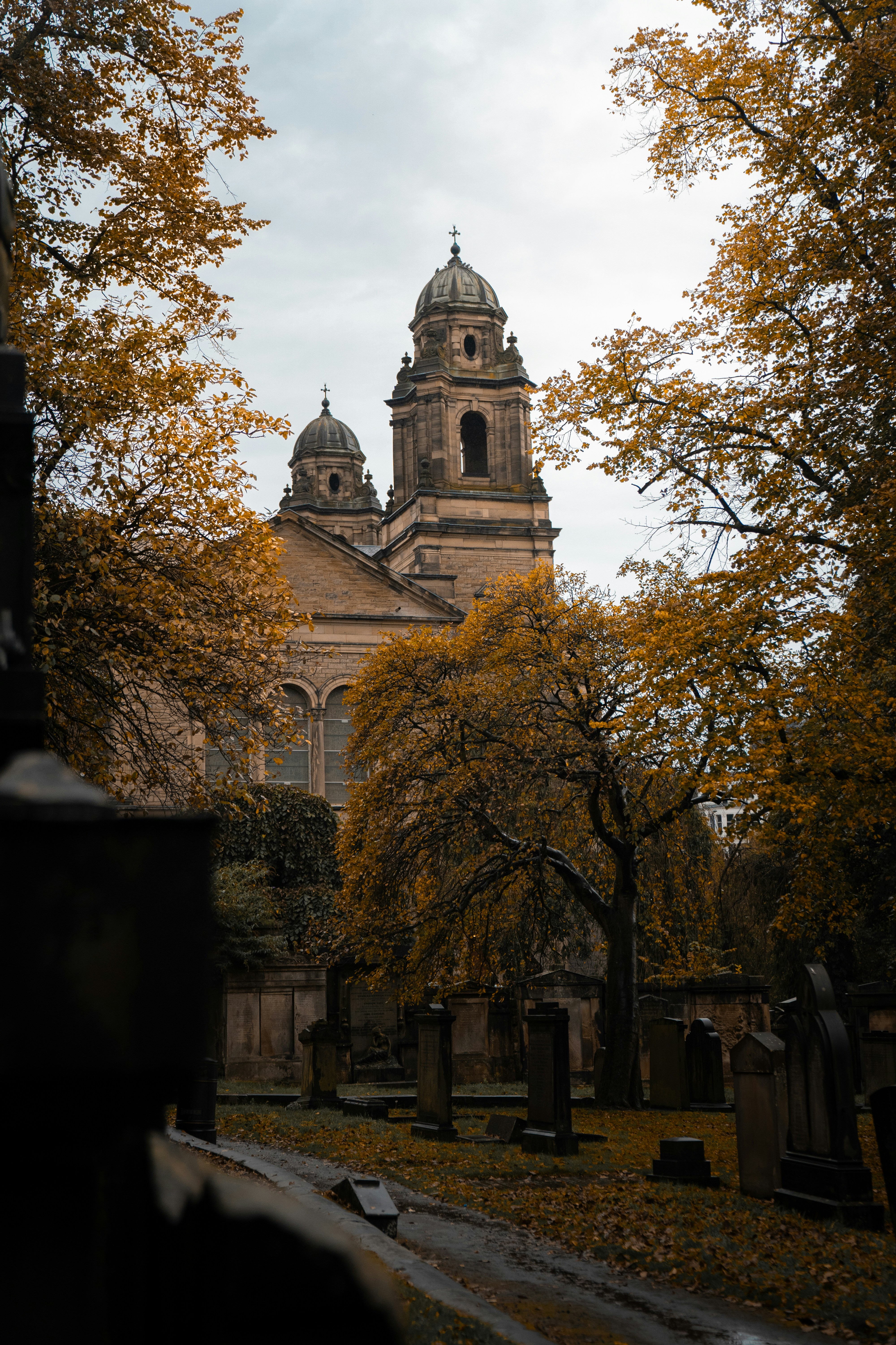 Autumn Lanterns: A Baroque Cathedral Framed by Gold Trees