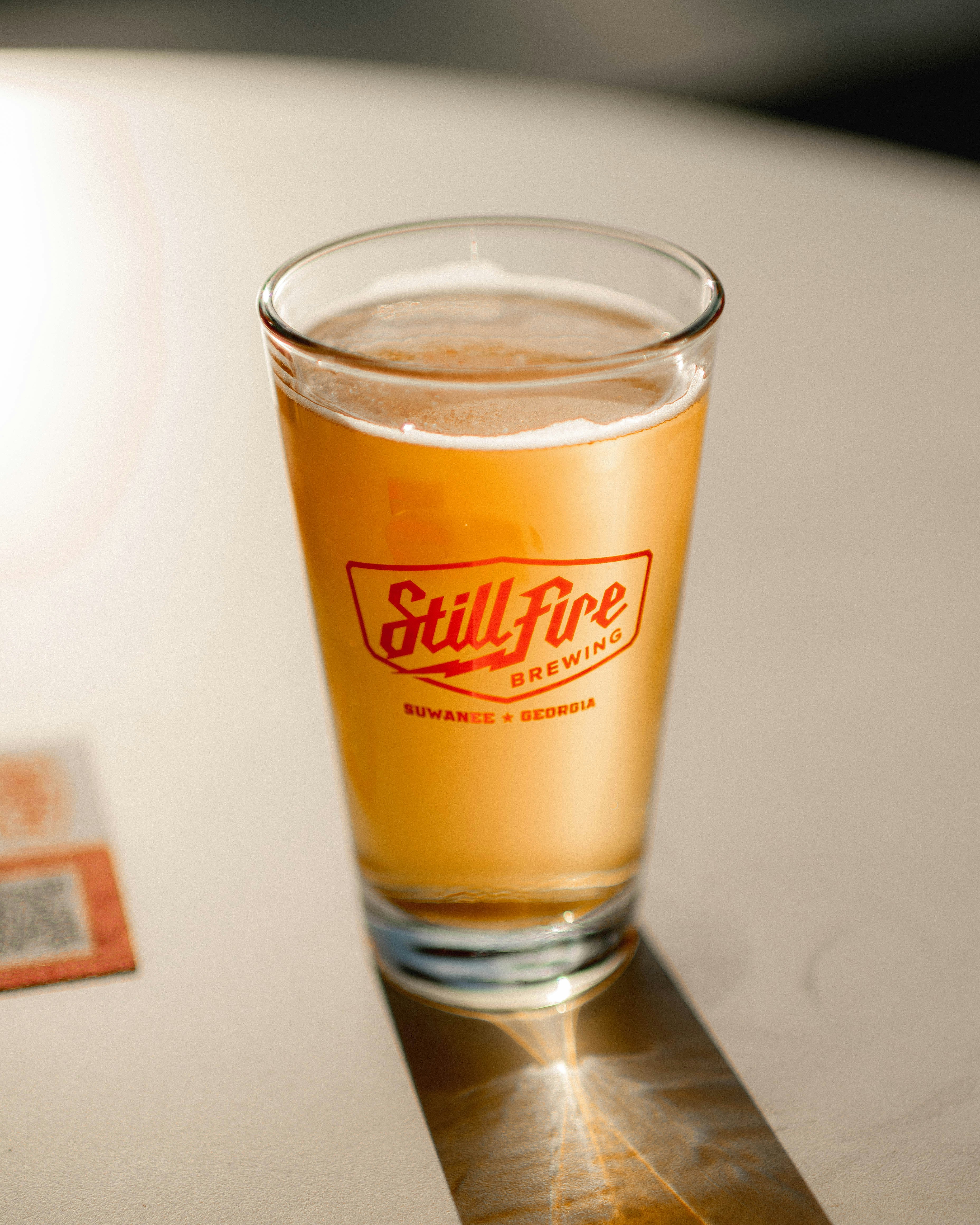 A glass of beer sitting on top of a table photo – Free Sun Image on ...