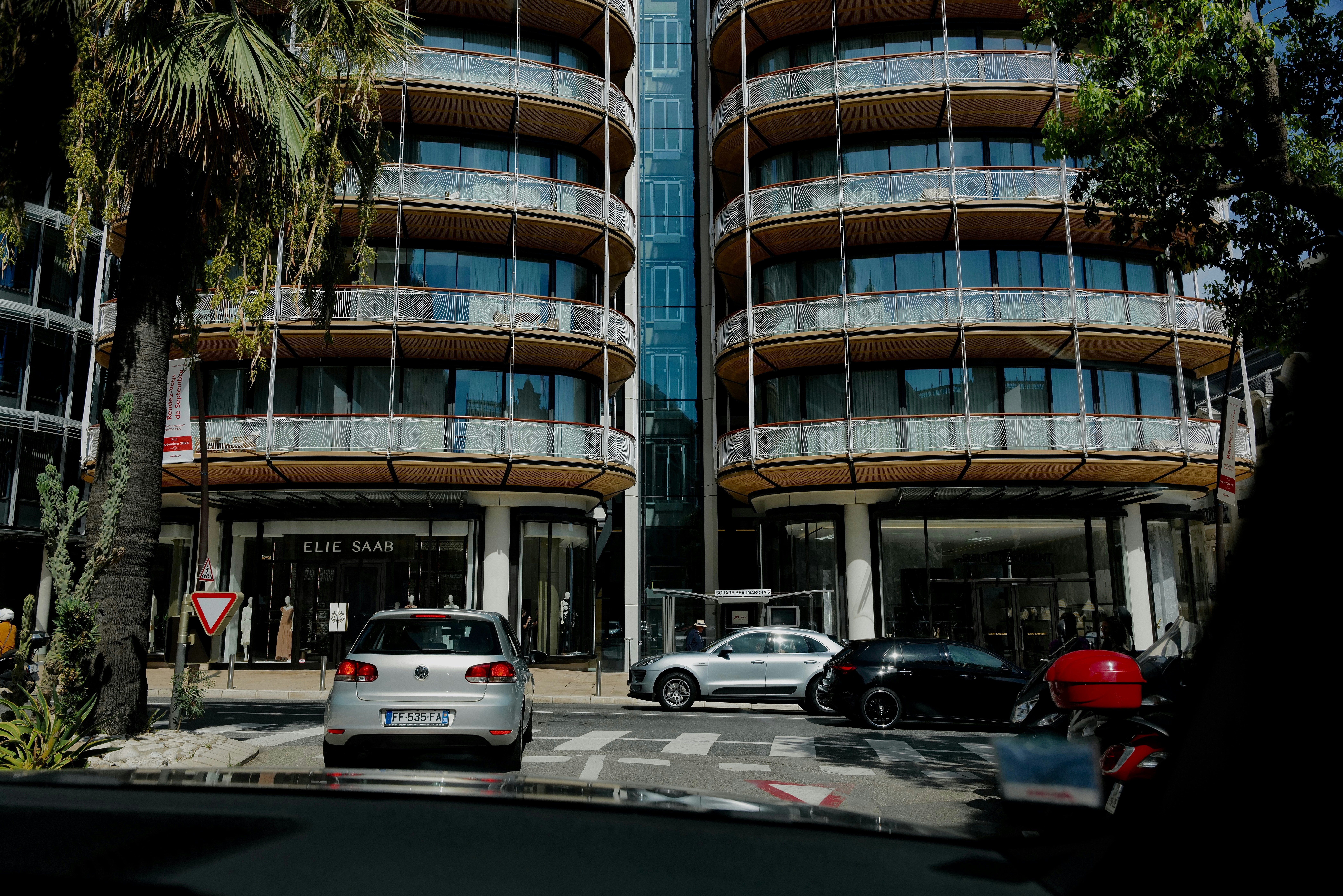 A large building with cars parked in front of it photo – Free Car Image ...