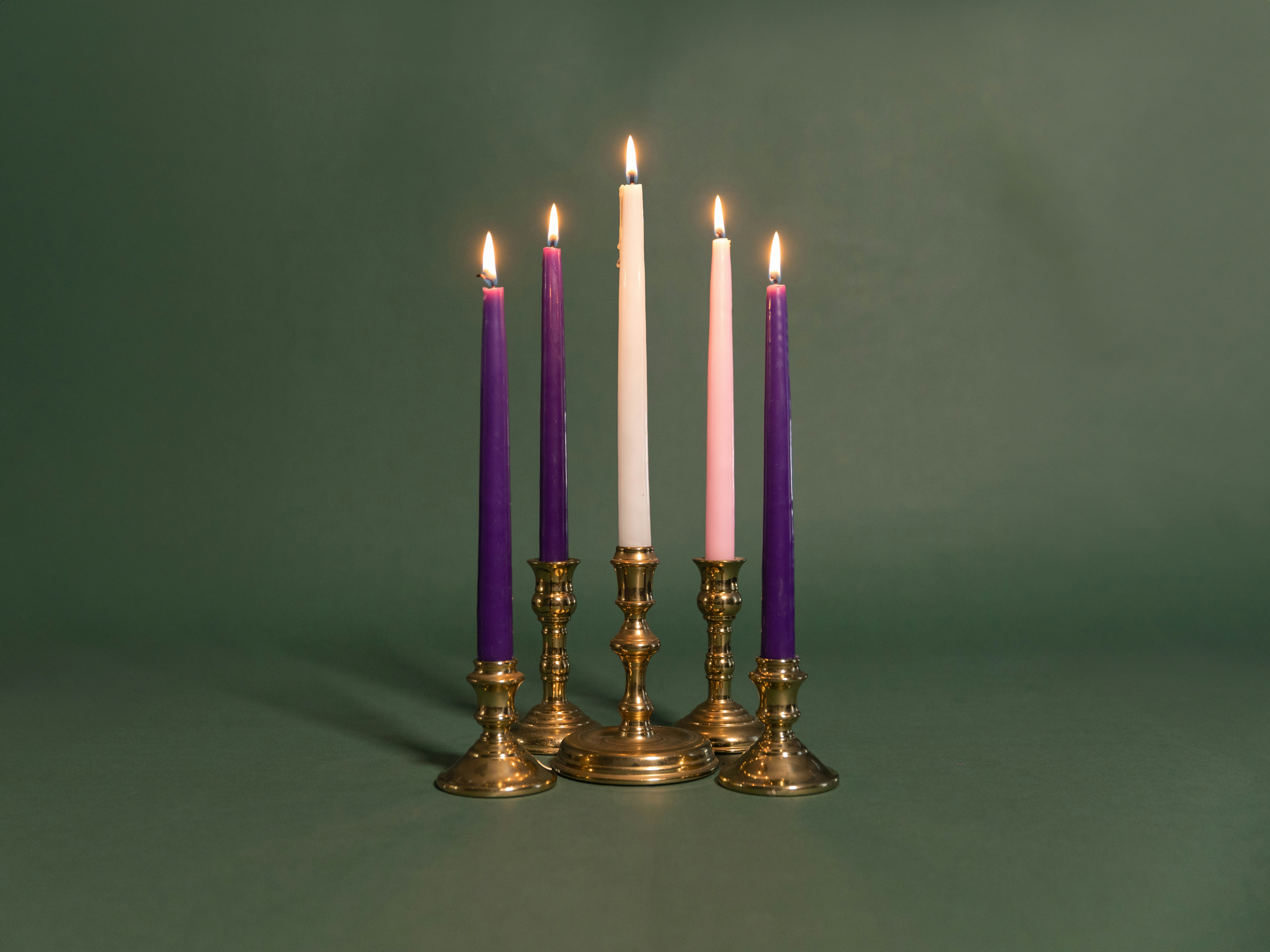A group of four candles sitting on top of a table photo – Free ...