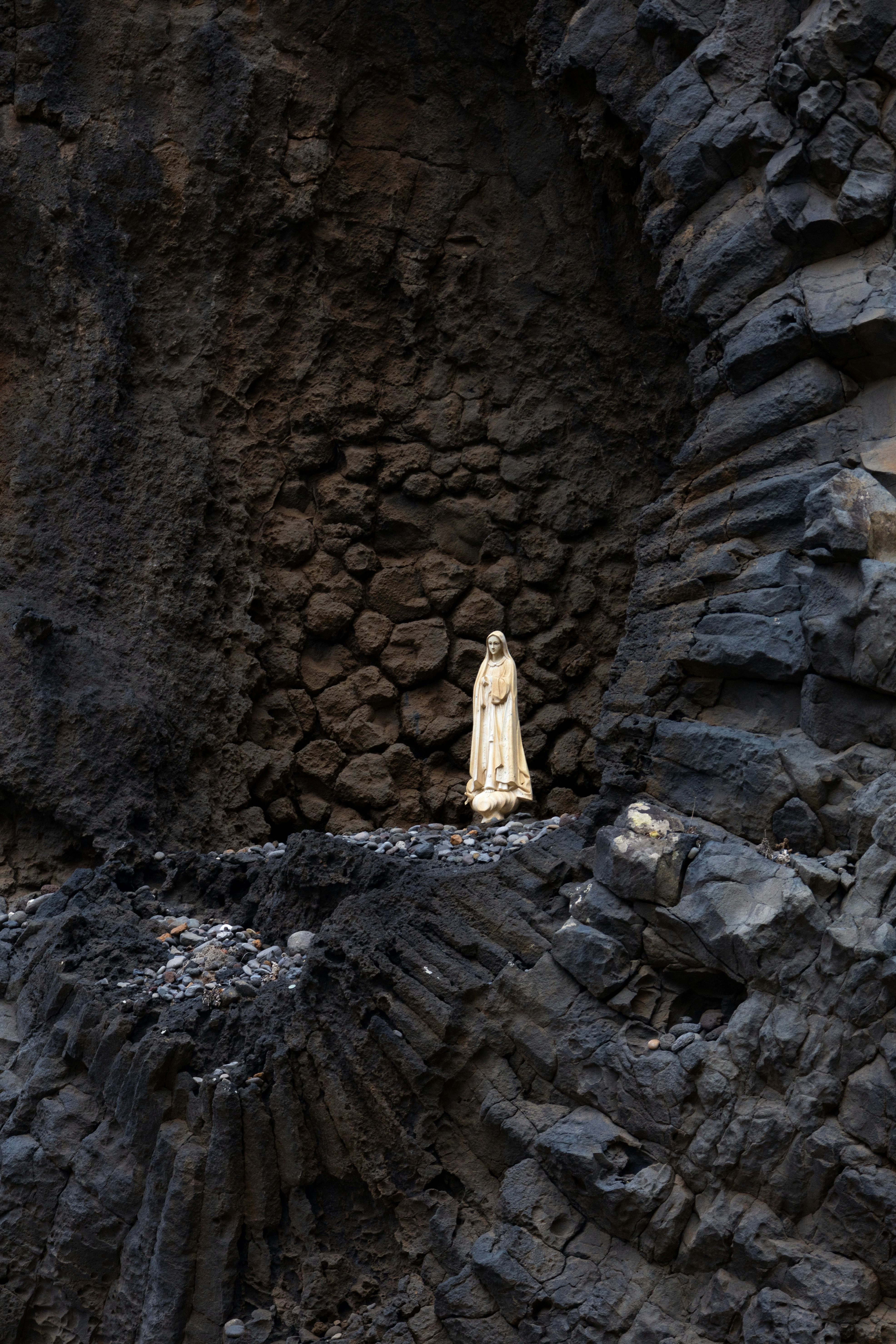 Basalt Cathedral: The Virgin Mary in a Lava-Cavern Shrine