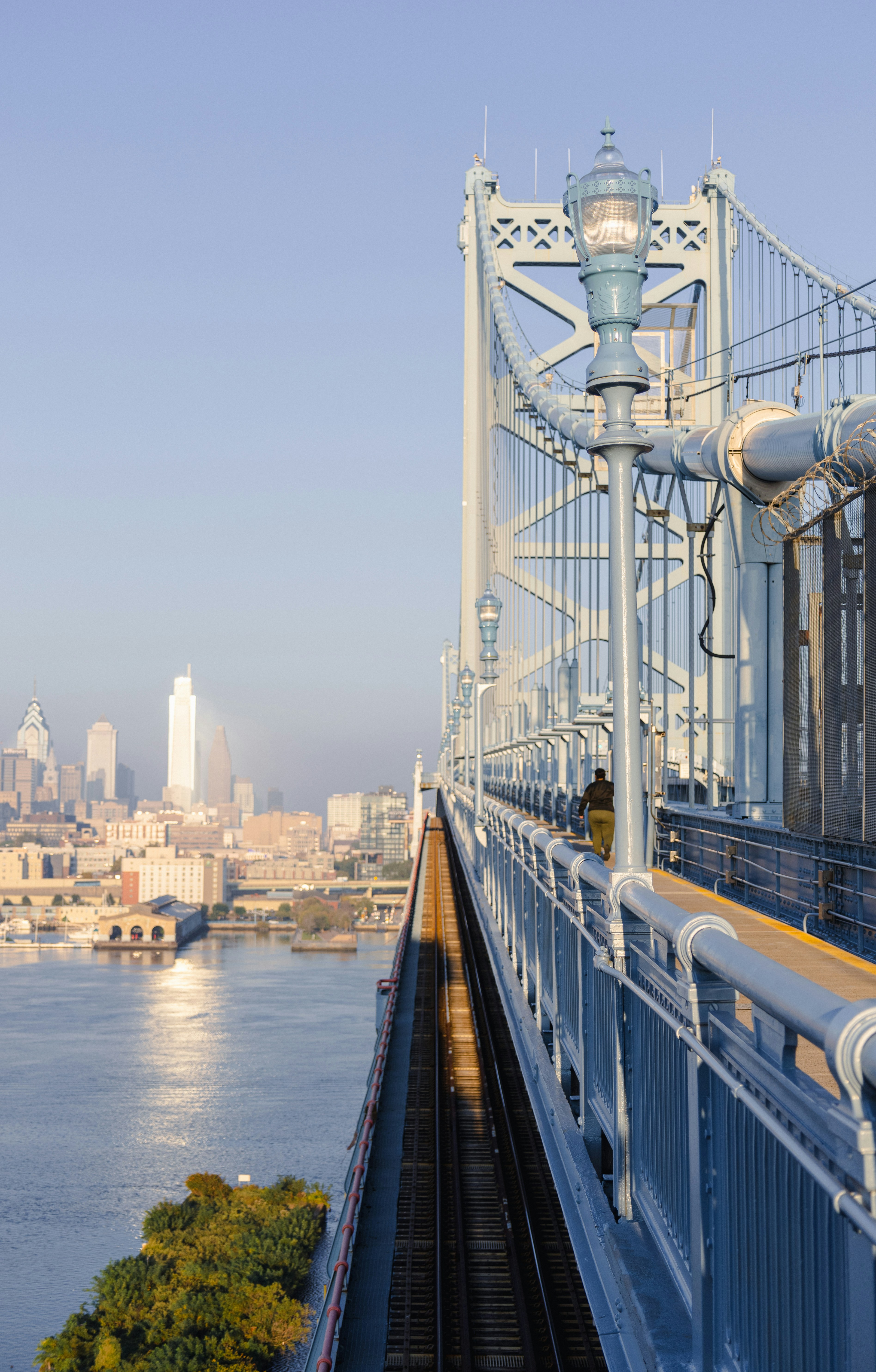 A train traveling over a bridge over a river photo – Free Sunrise Image ...