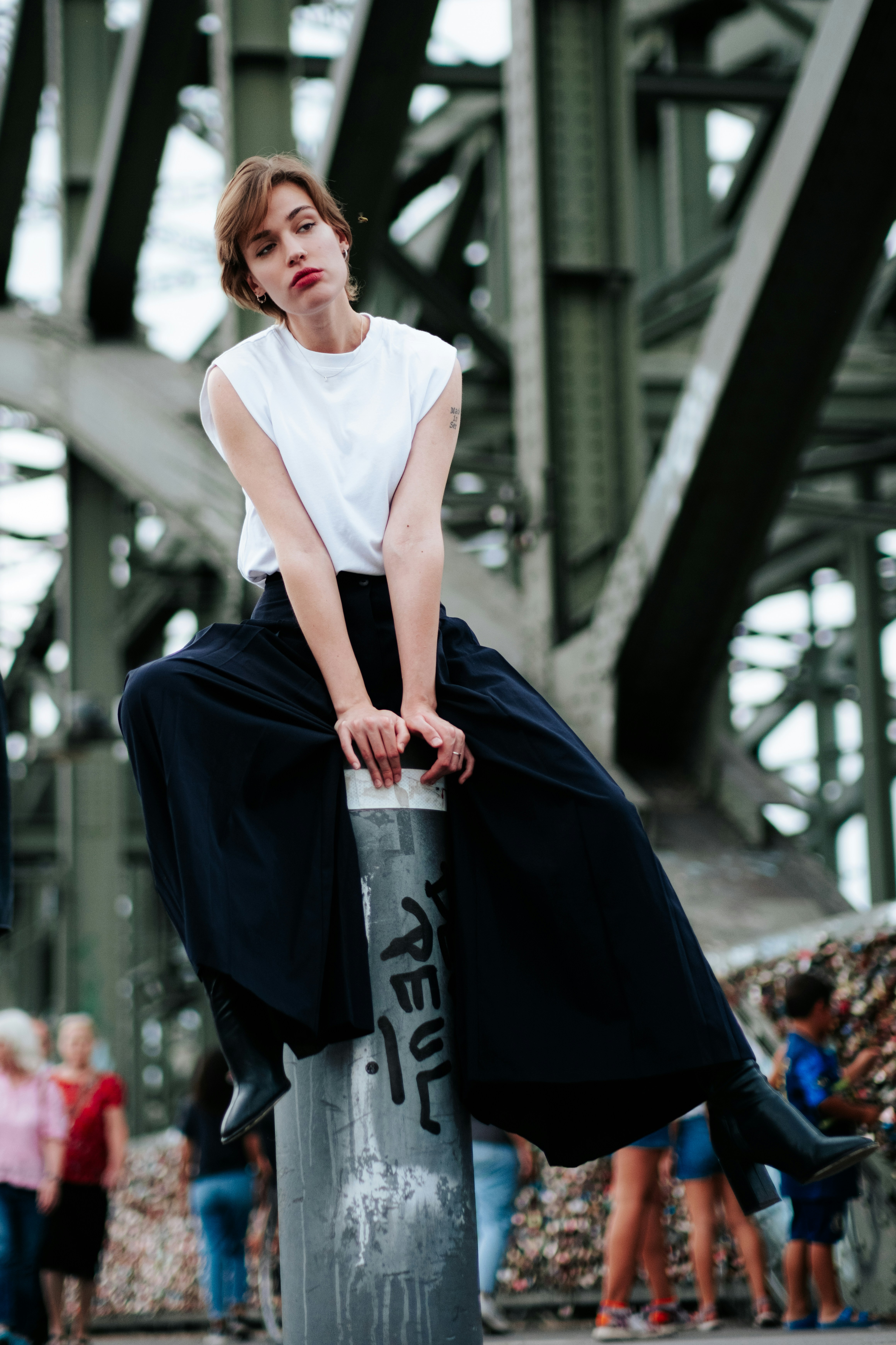 A woman standing on top of a fire hydrant photo – Free Woman Image on ...