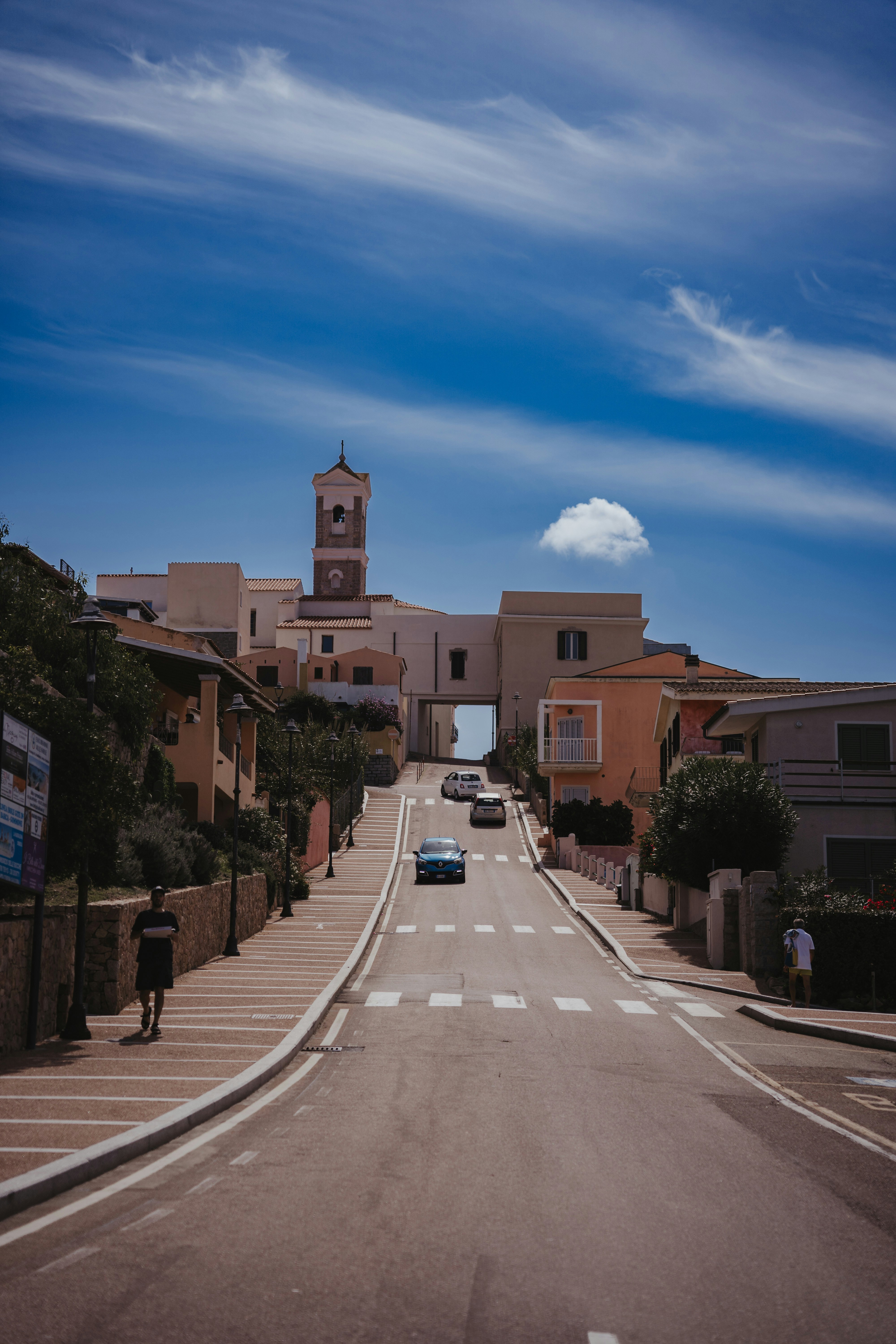 Archway Ascent: A sunlit climb toward the hilltop clock tower