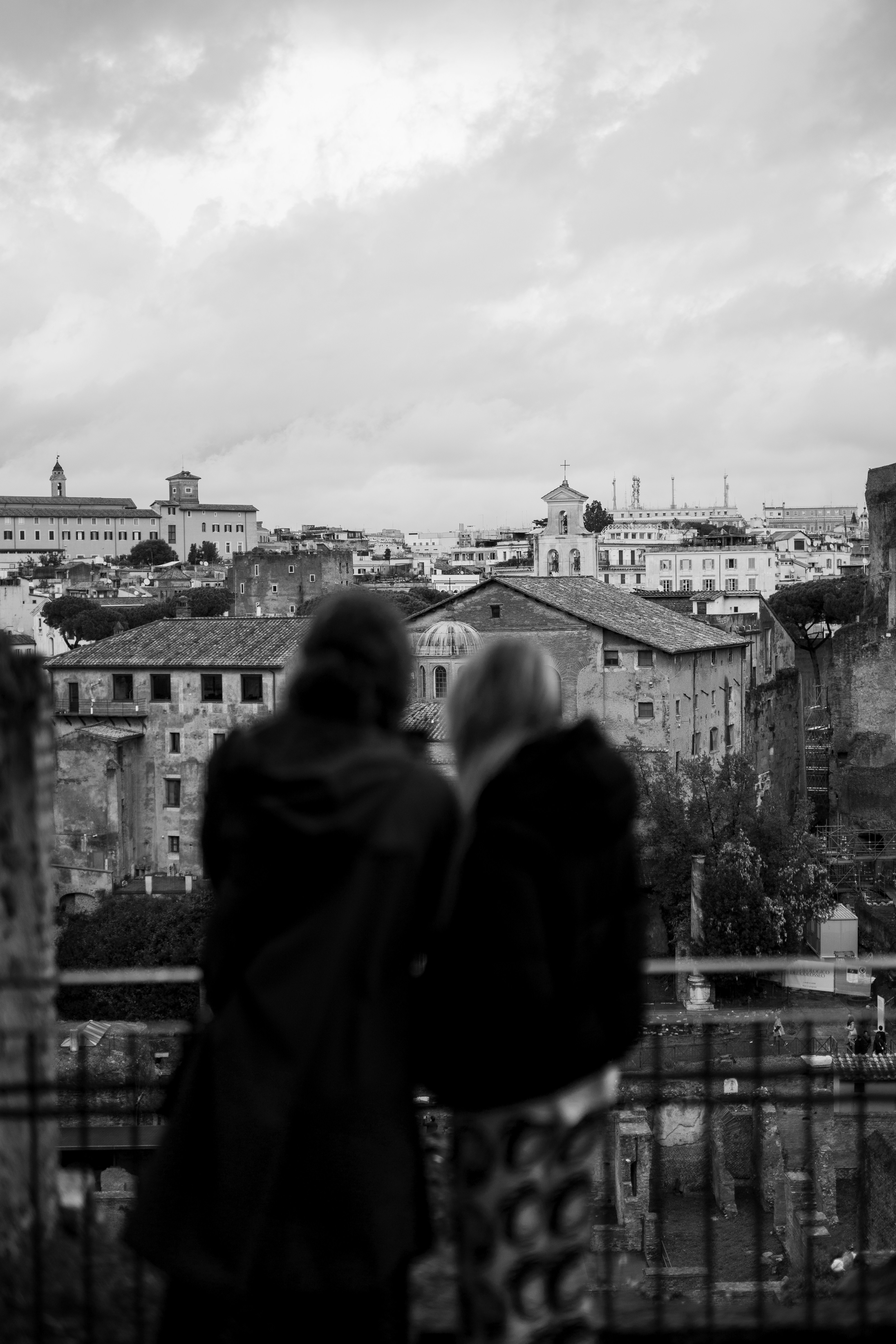 A couple of people standing on top of a bridge photo – Free Woman Image ...