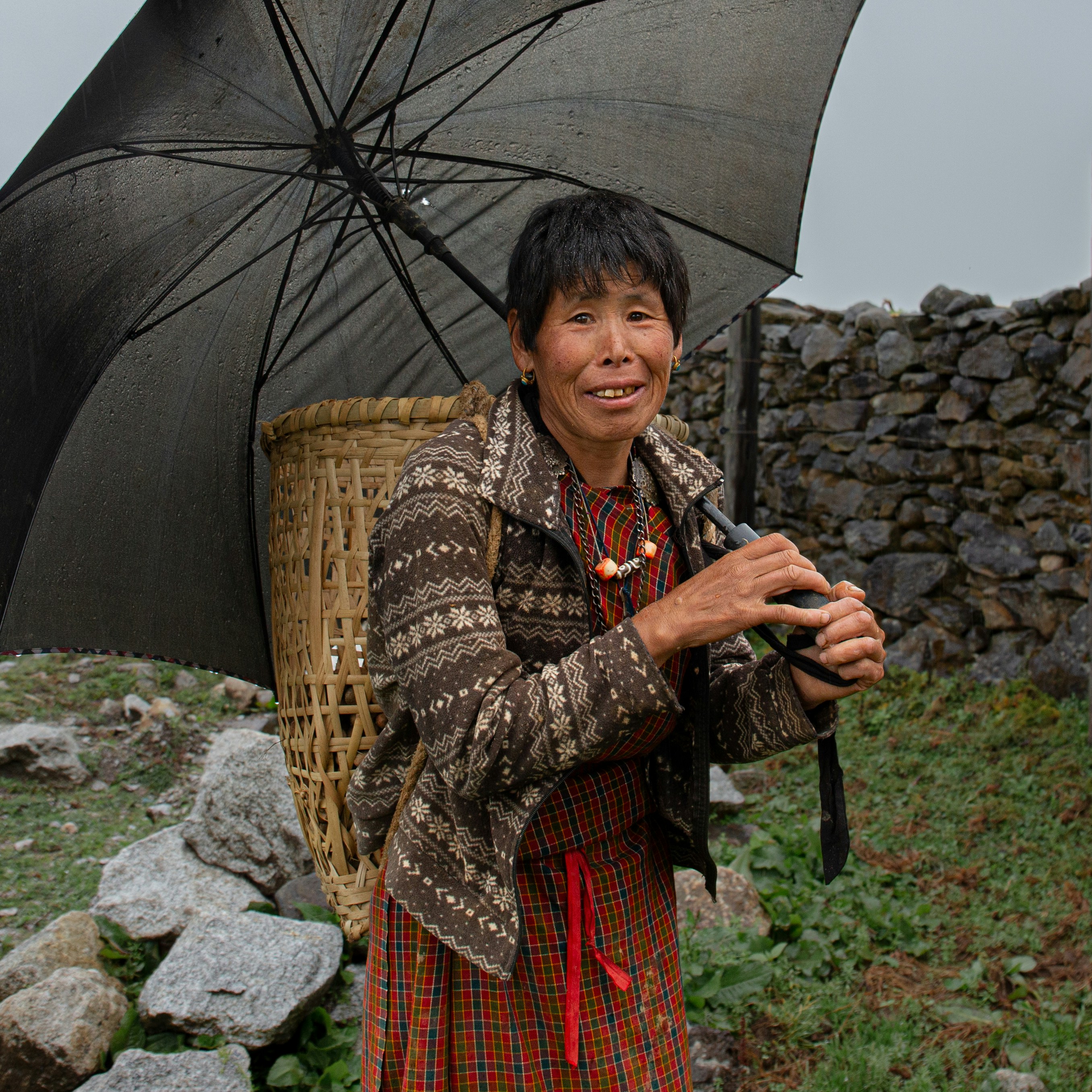 Umbrella Portrait in a Mountain Village: A Graceful Moment with Traditional Attire