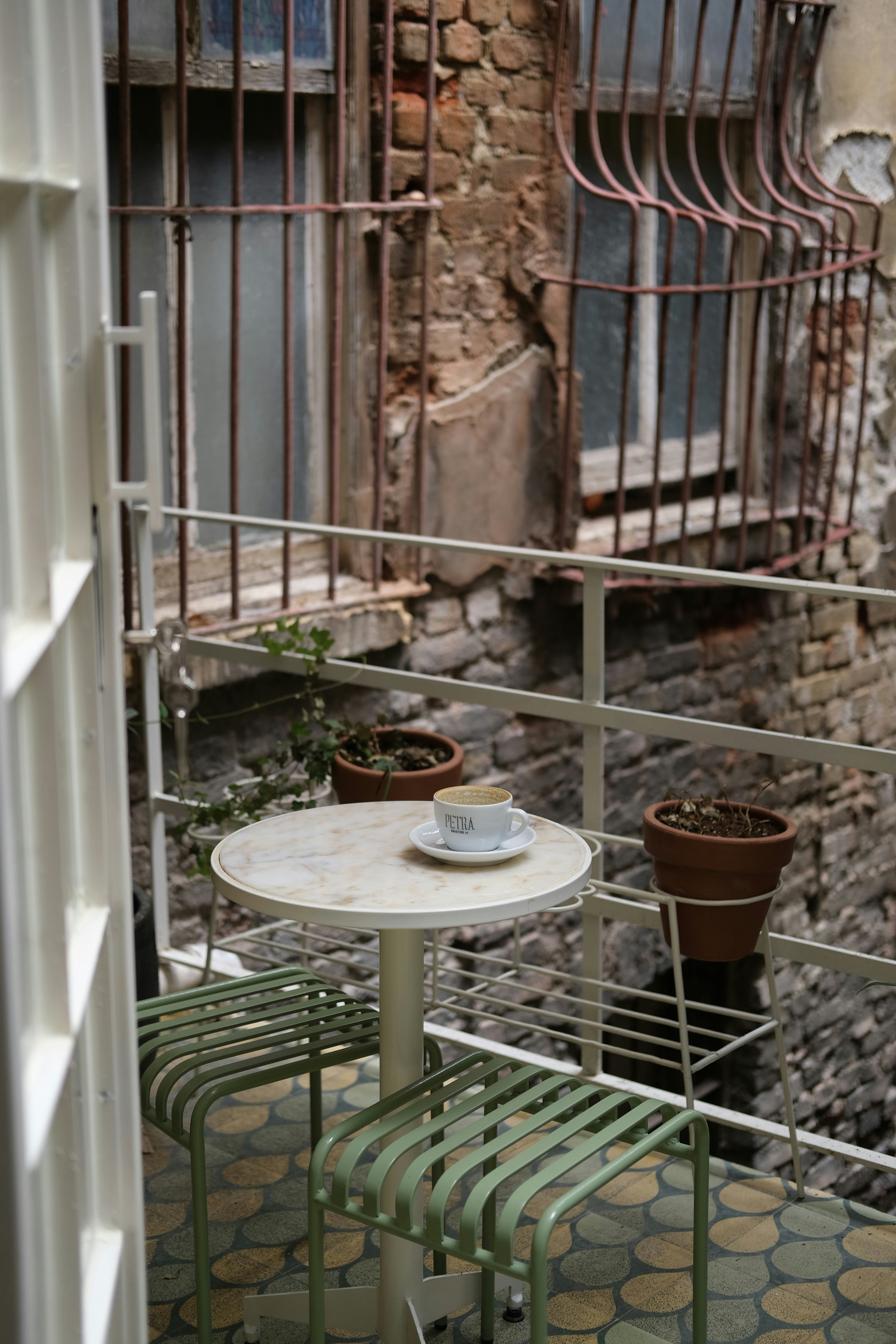 Quiet Morning Ottoman: Coffee on a City Balcony