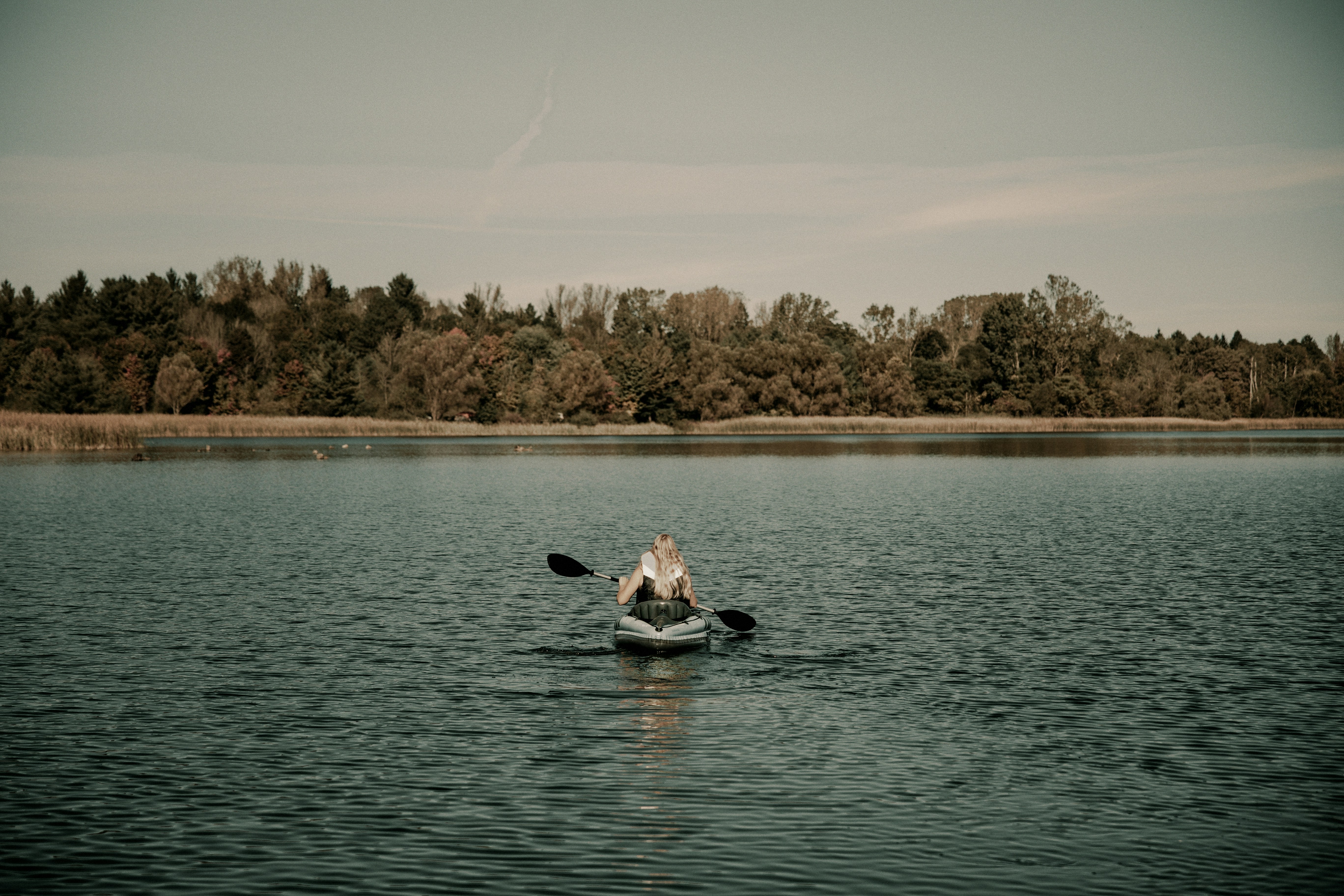 Centered Silence: Kayaker Beneath a Wide Sky