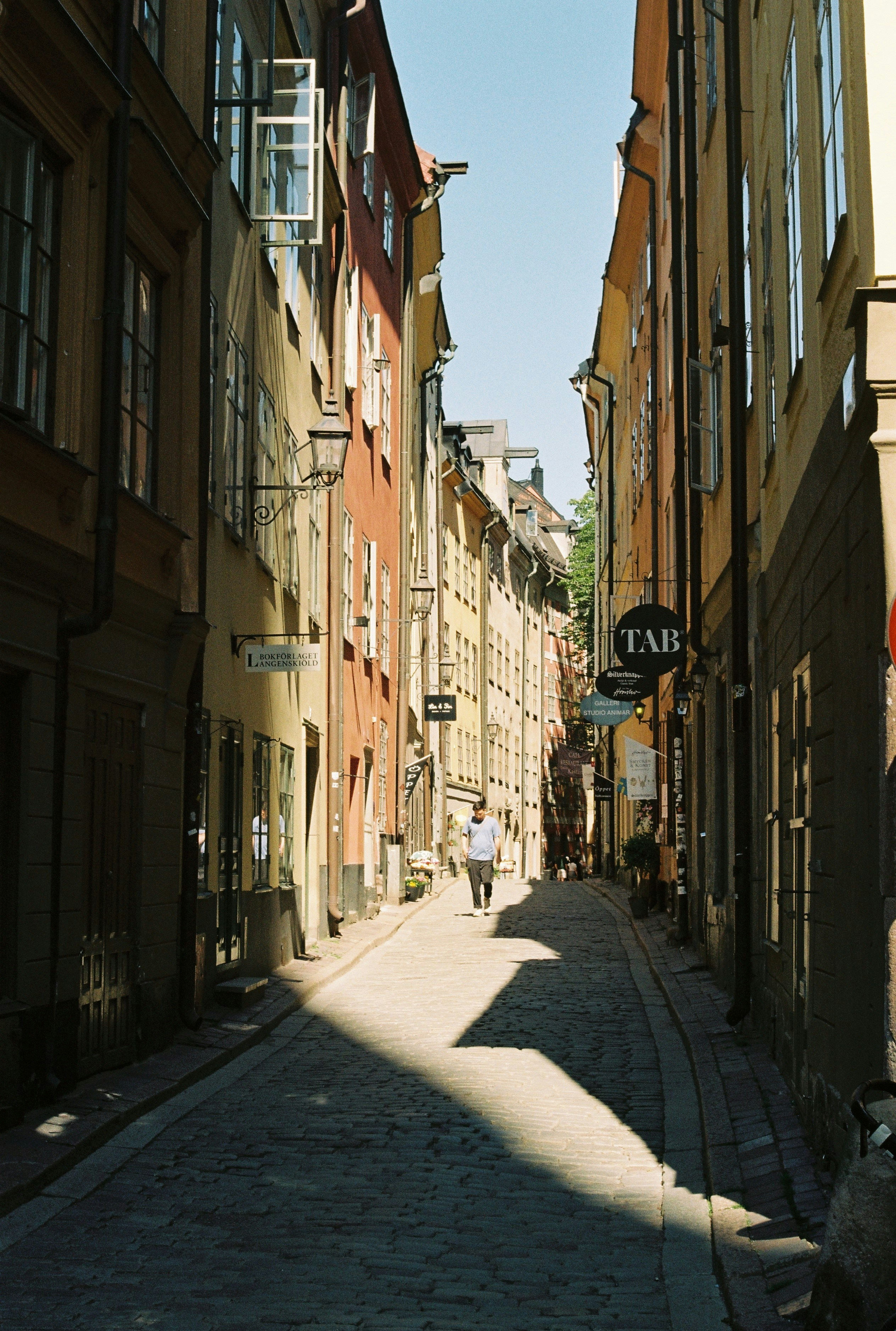 A narrow city street lined with tall buildings photo – Free Stockholm ...