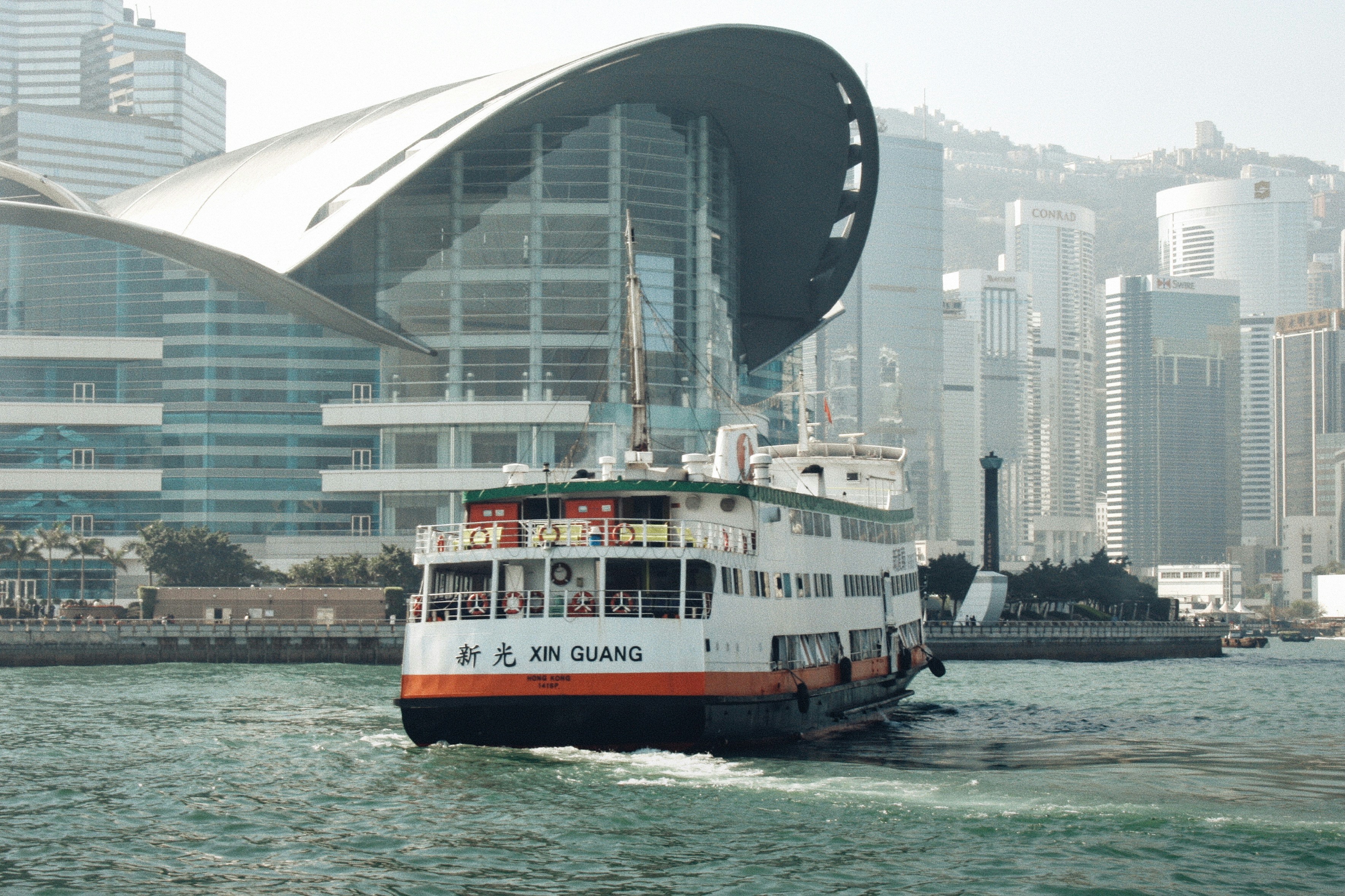 Harbor Ferry Surging Beneath a Modern Skyline