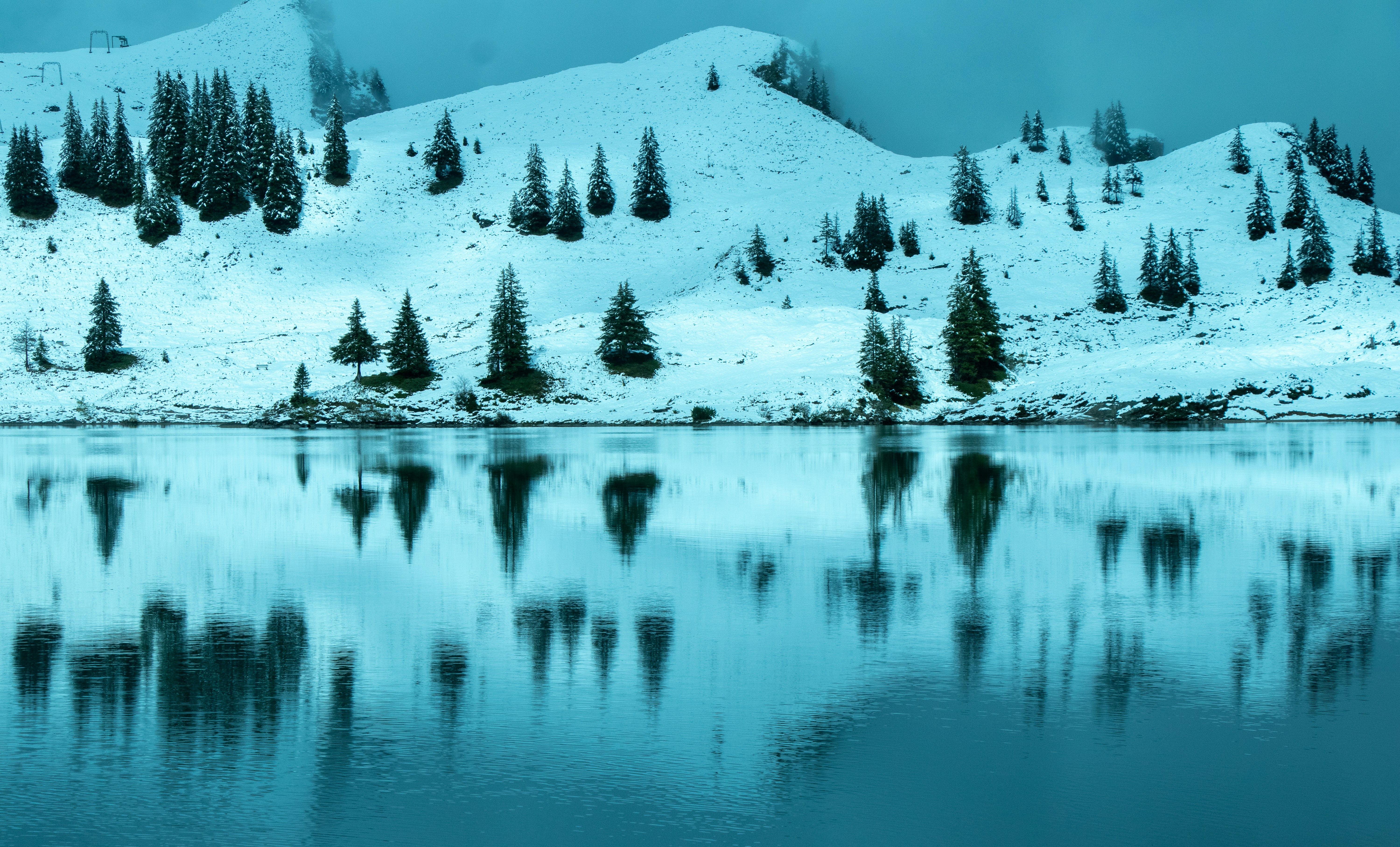 Blue Silence Above Snow-Dusted Pines Reflected in a Glassy Lake