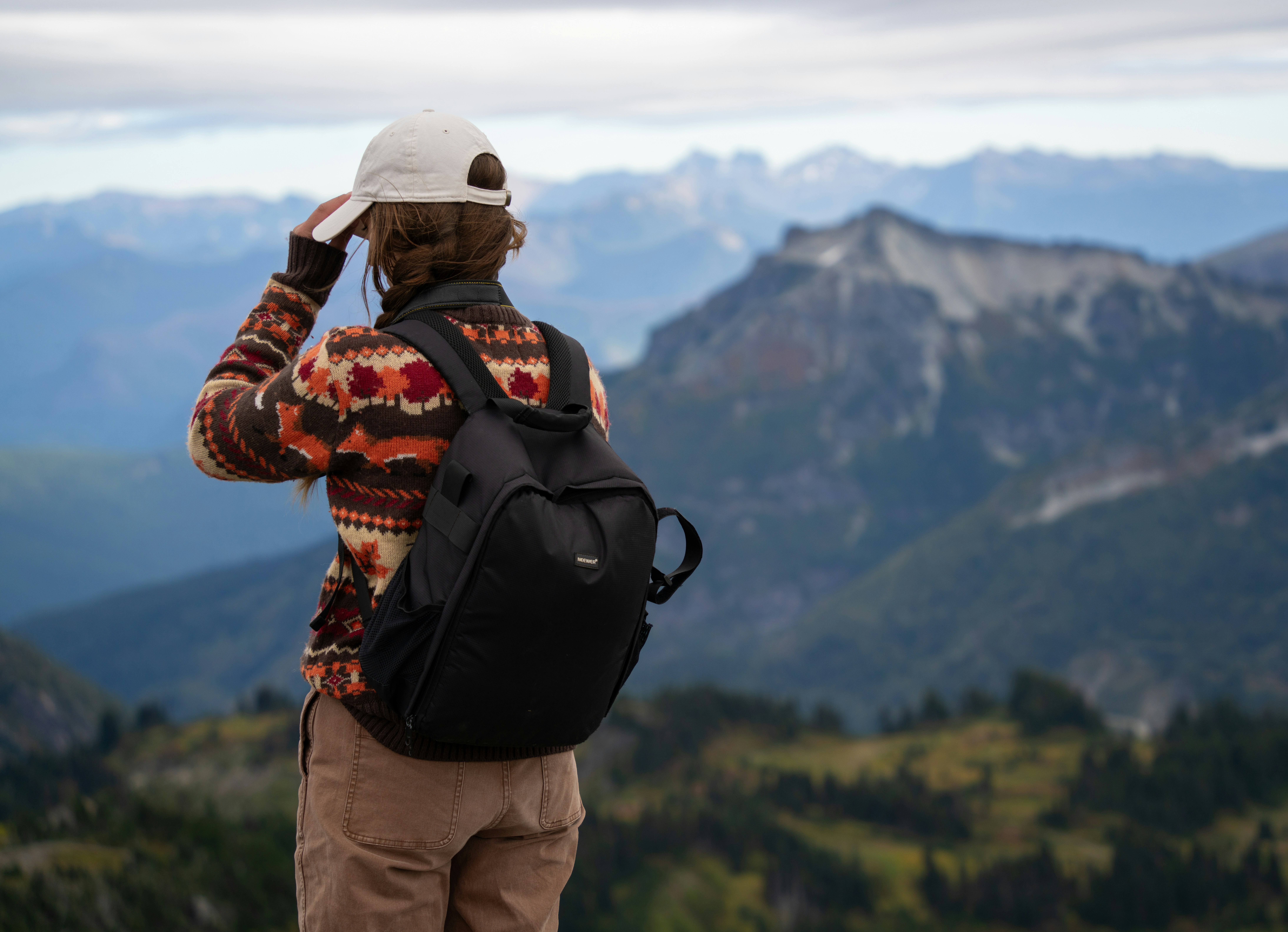 Trailbound in Patterned Light: A Hiker Overlooking Alpine Giants
