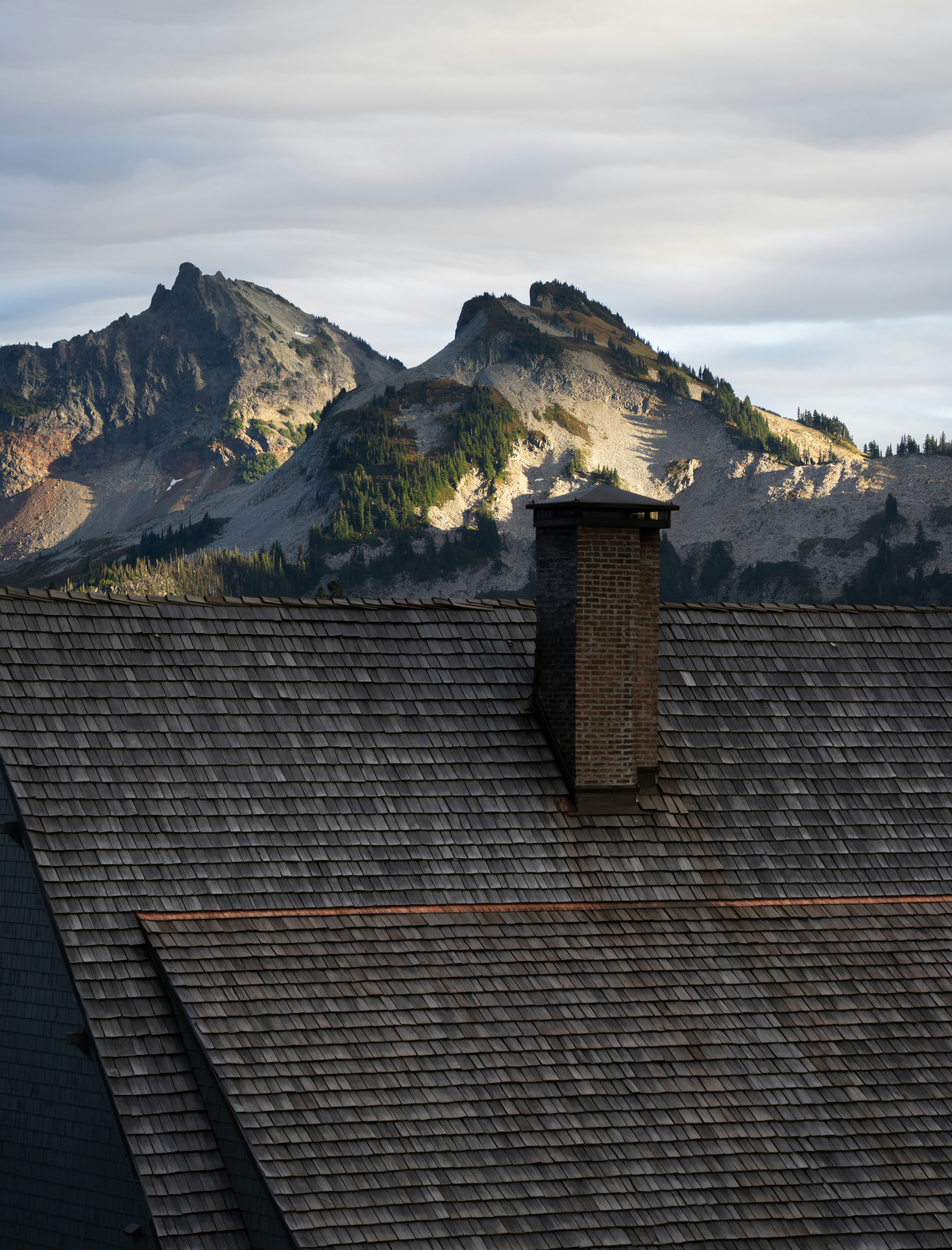 A view of a mountain range from the roof of a house