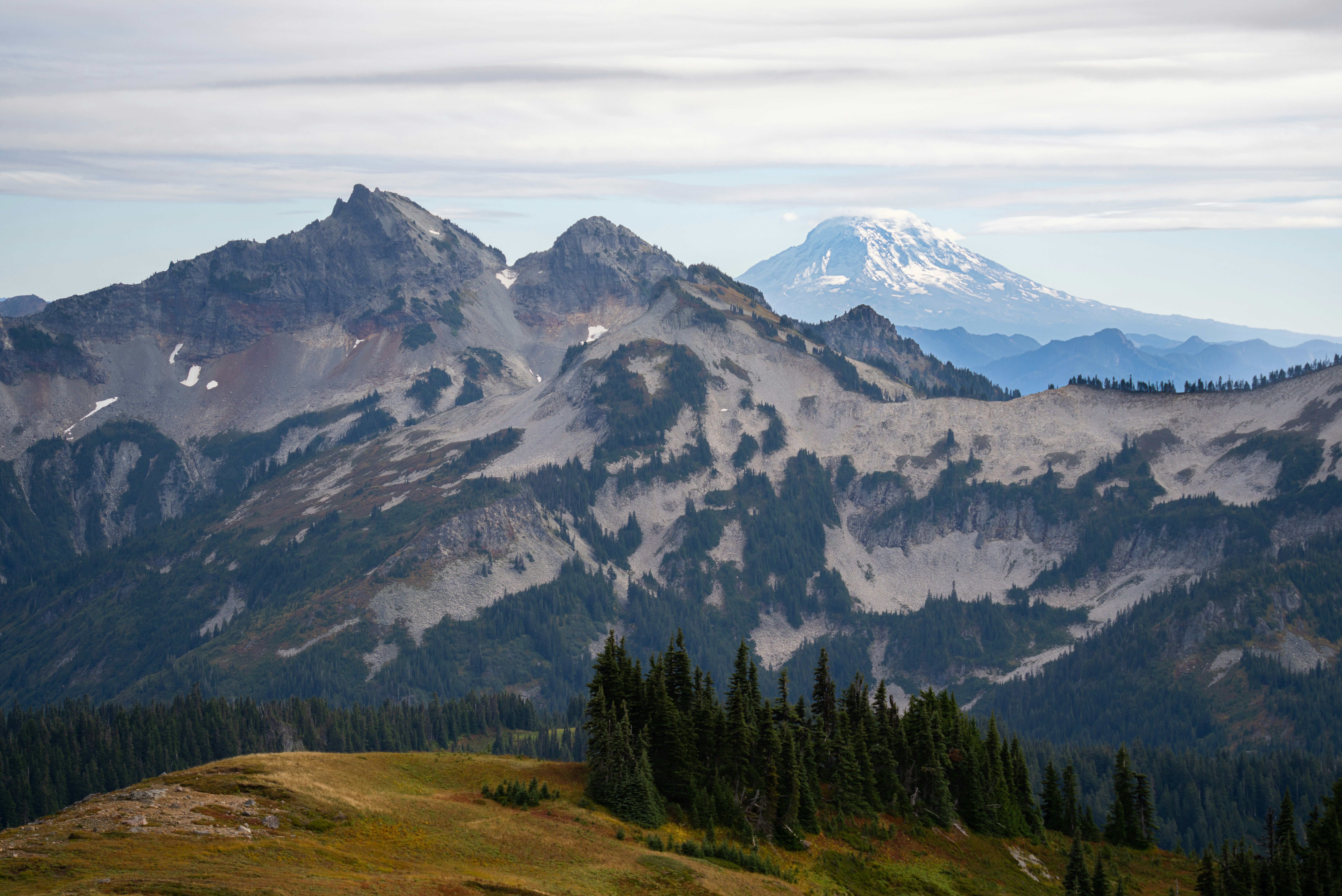 A view of a mountain range with trees and mountains in the background ...