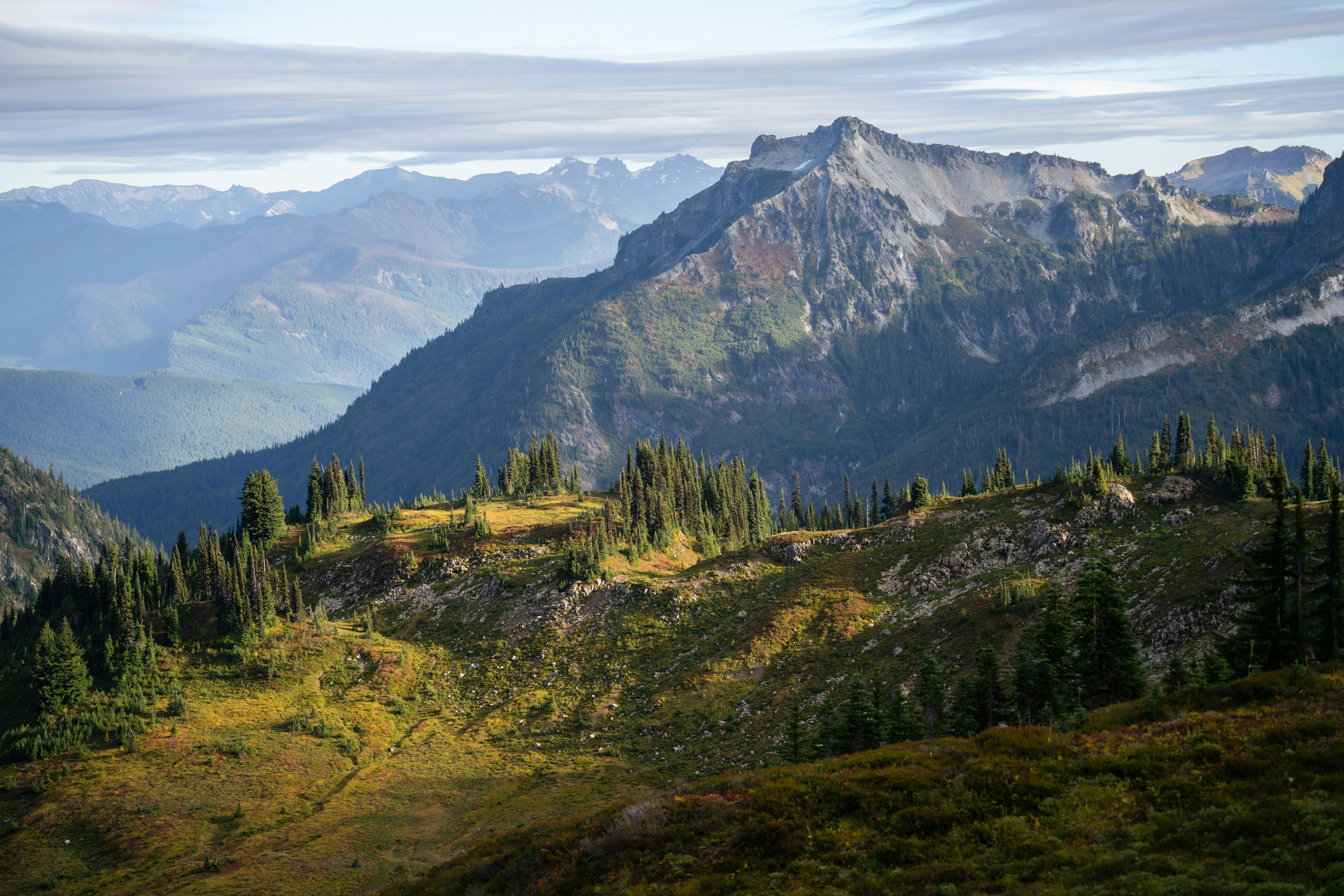A view of a mountain range with trees and mountains in the background ...