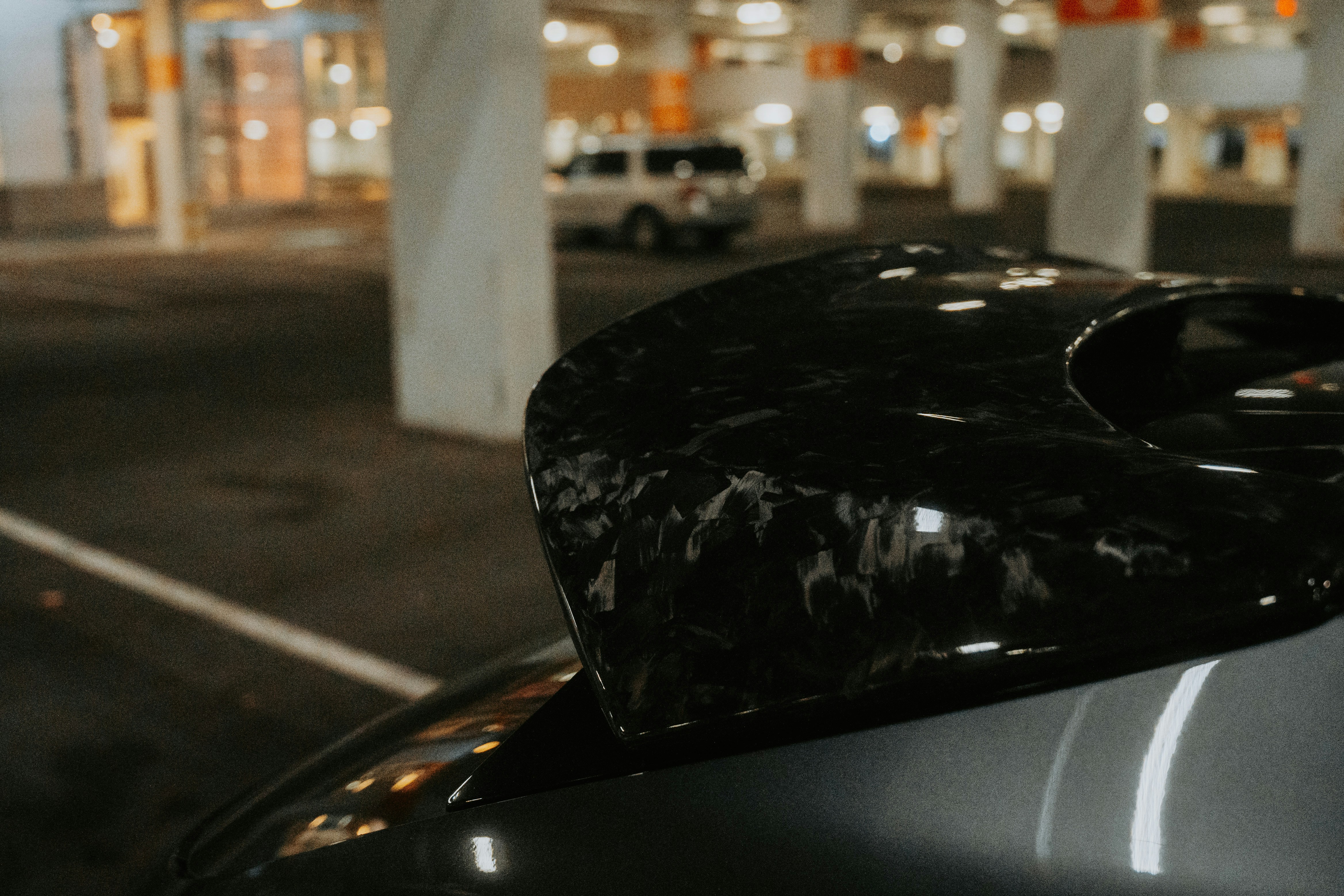 Night Parking Lot Gleam: A Close-Up on Curved Gloss